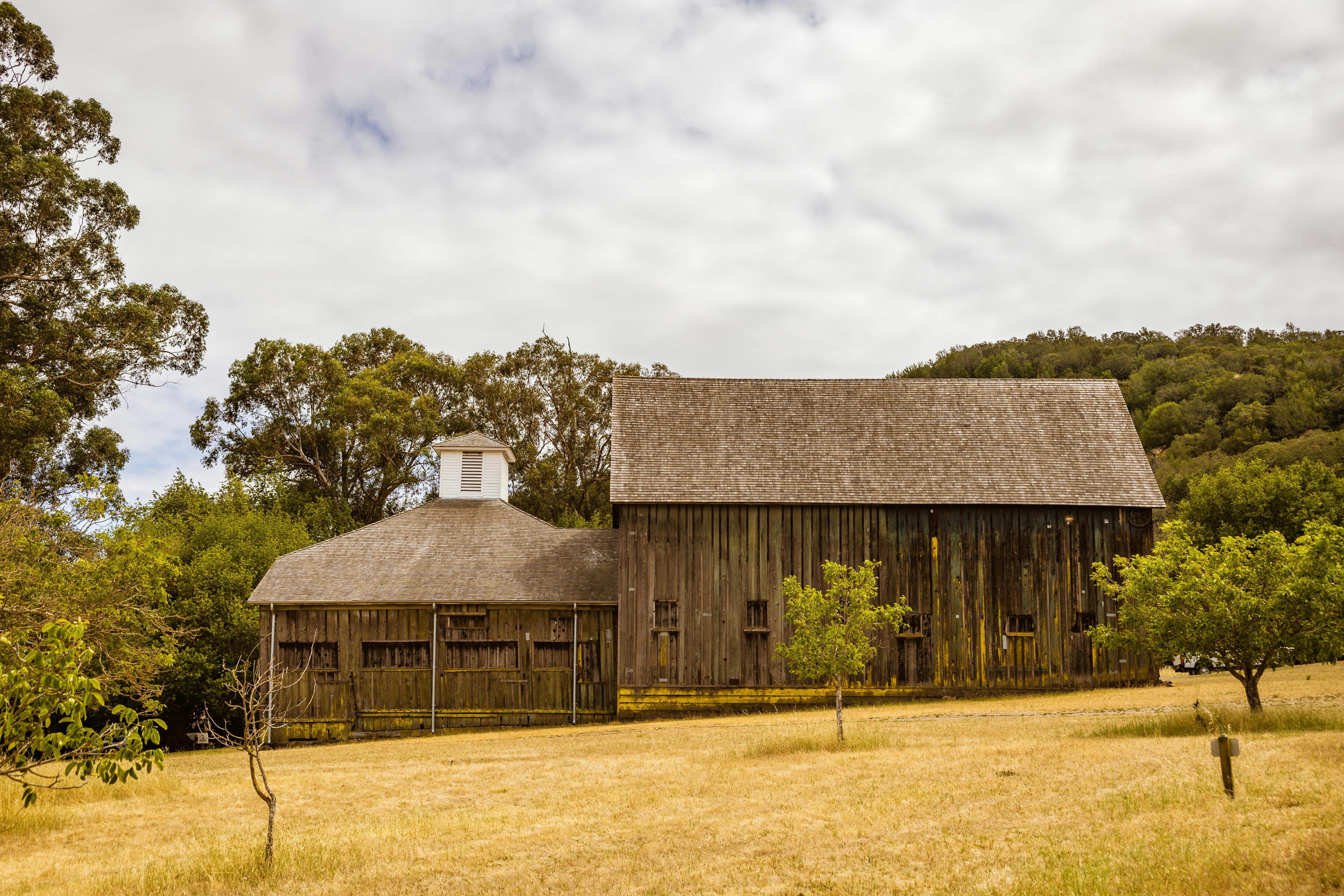 Wooden Barn Beside Green Trees · Free Stock Photo