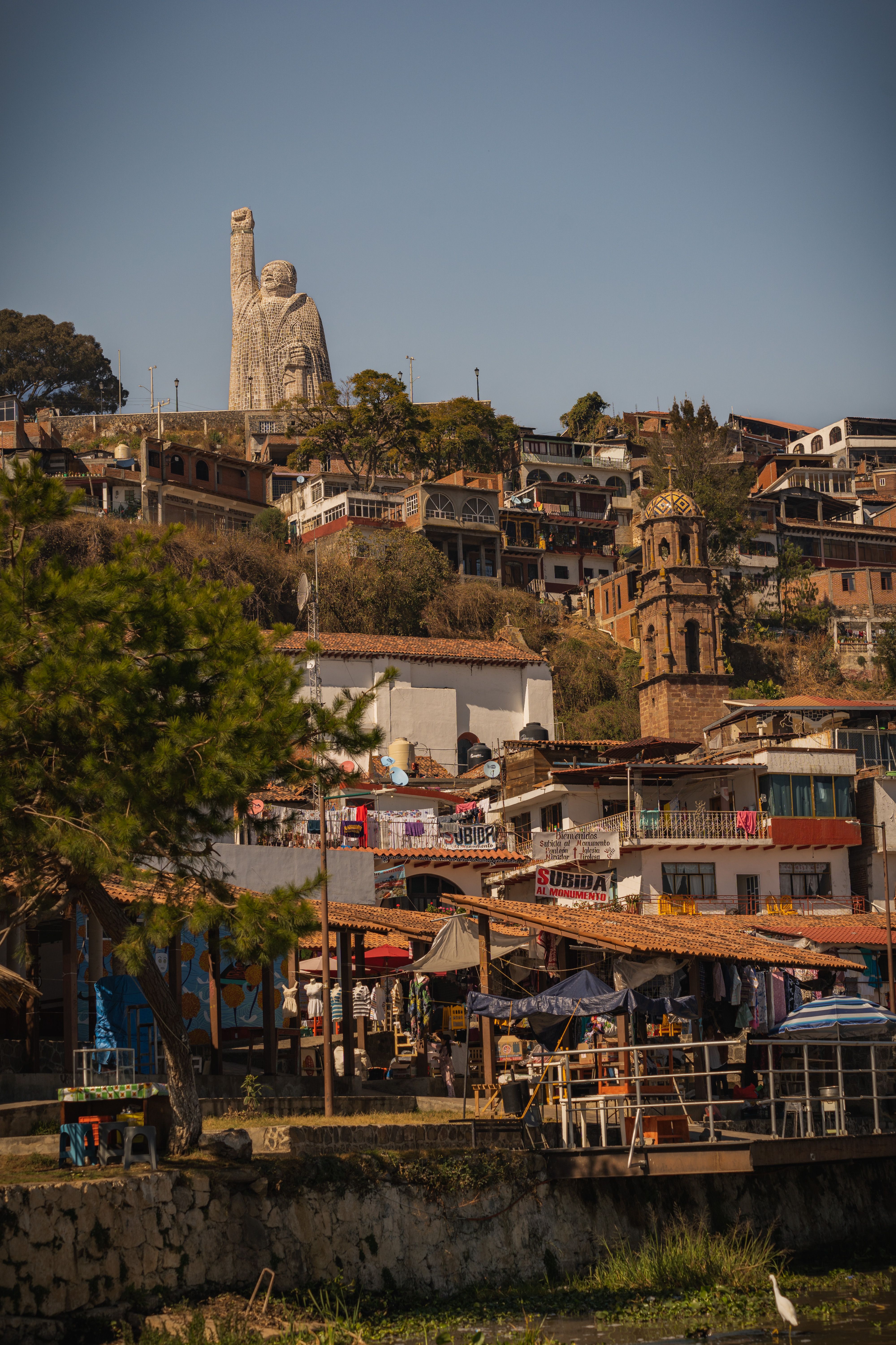 Town on Hill with Statue · Free Stock Photo