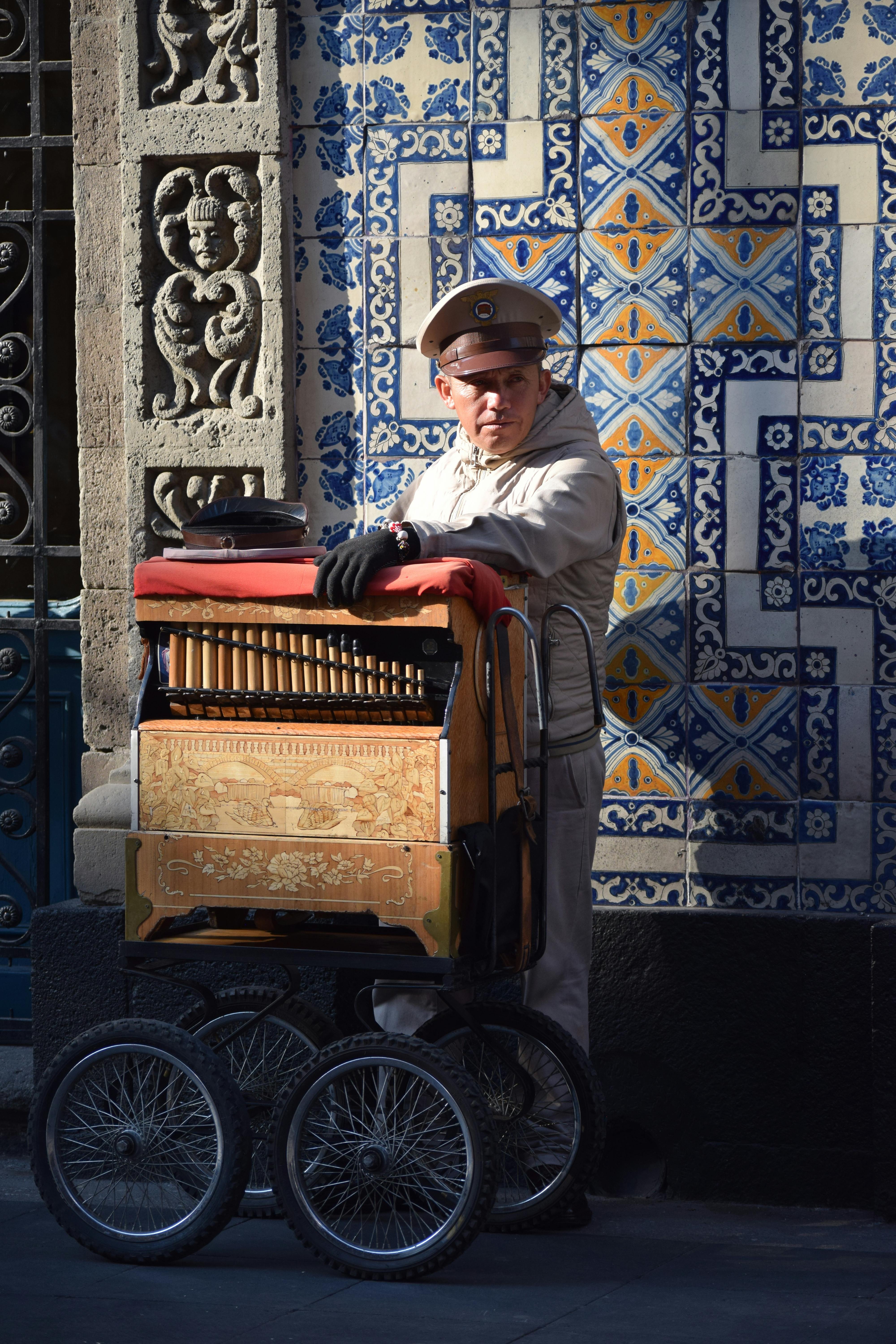 Man Standing Beside a Barrel Organ · Free Stock Photo