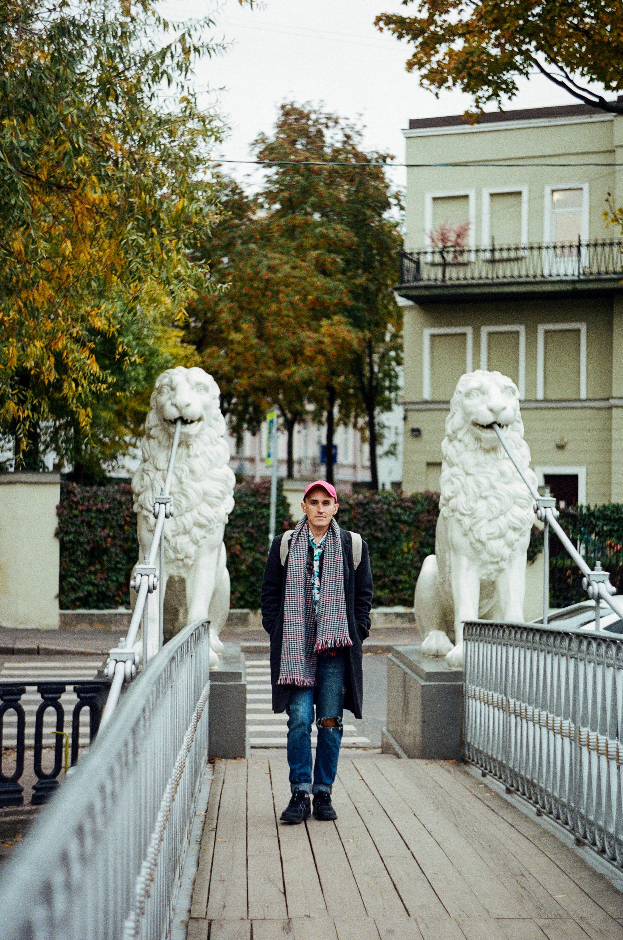 Man Walking near Ornamented Statues by Stairs · Free Stock Photo