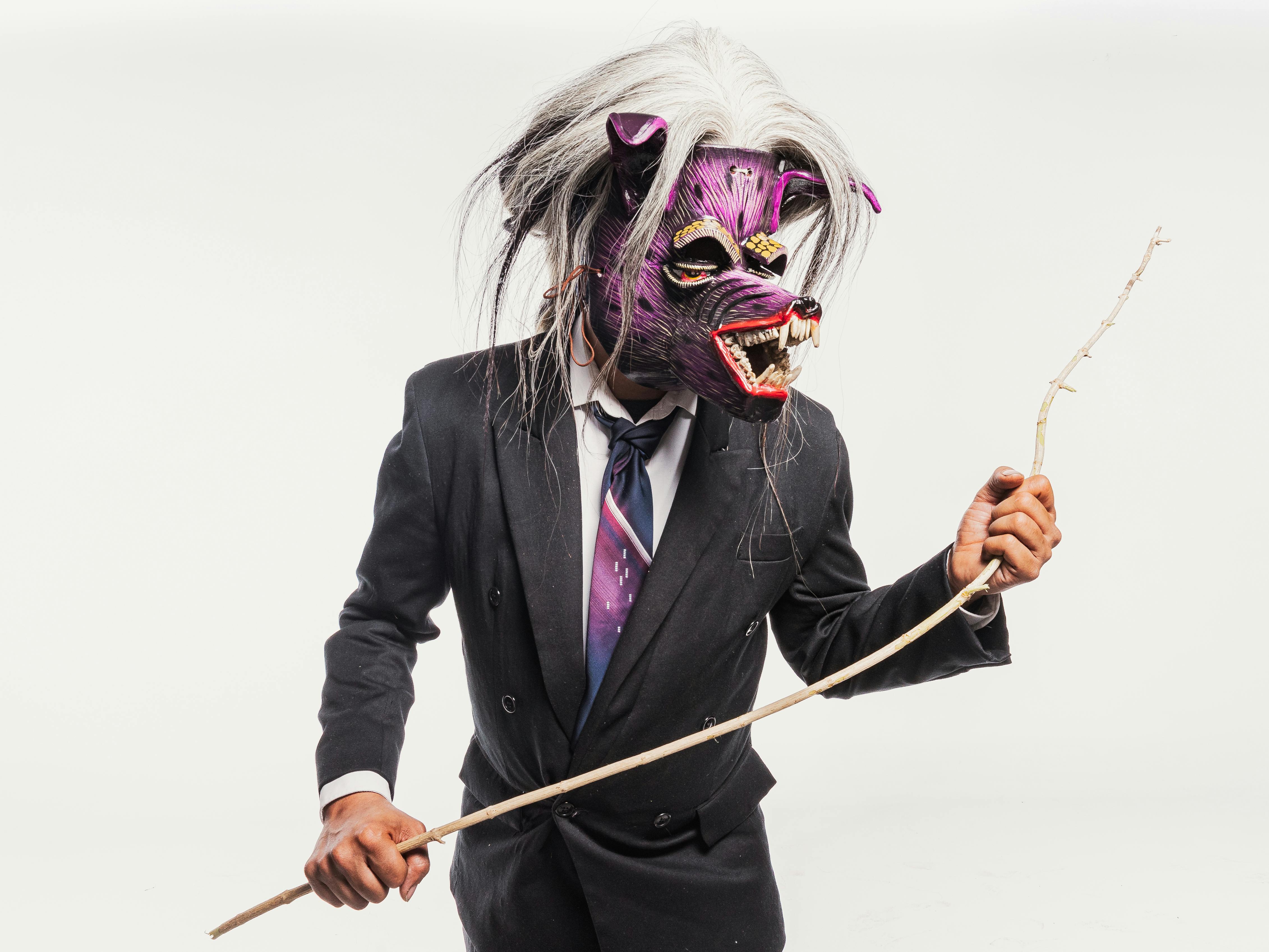 Studio Shot of a Man in a Suit and Purple Mask · Free Stock Photo