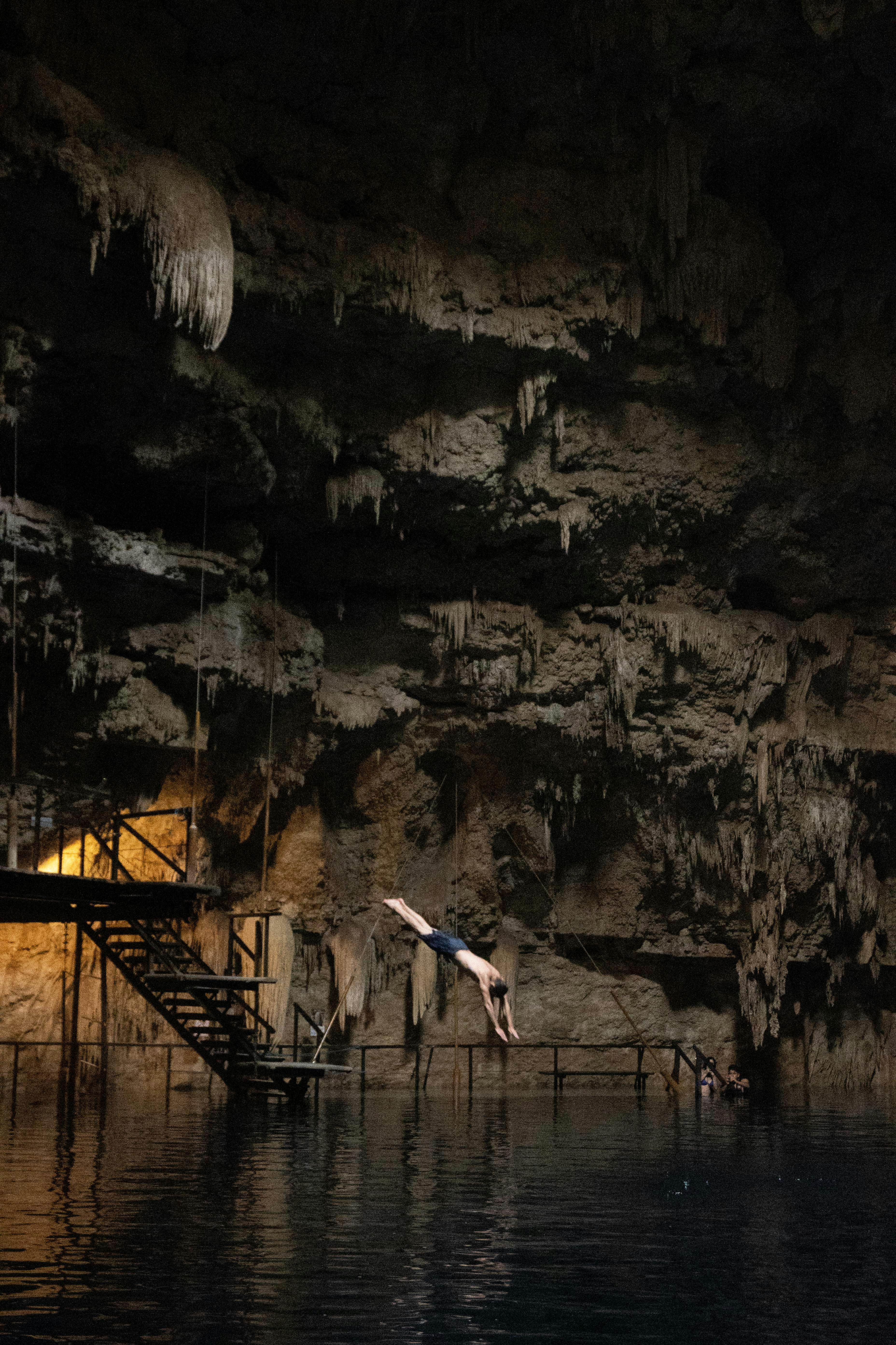 Man Jumping to Water in Cave · Free Stock Photo