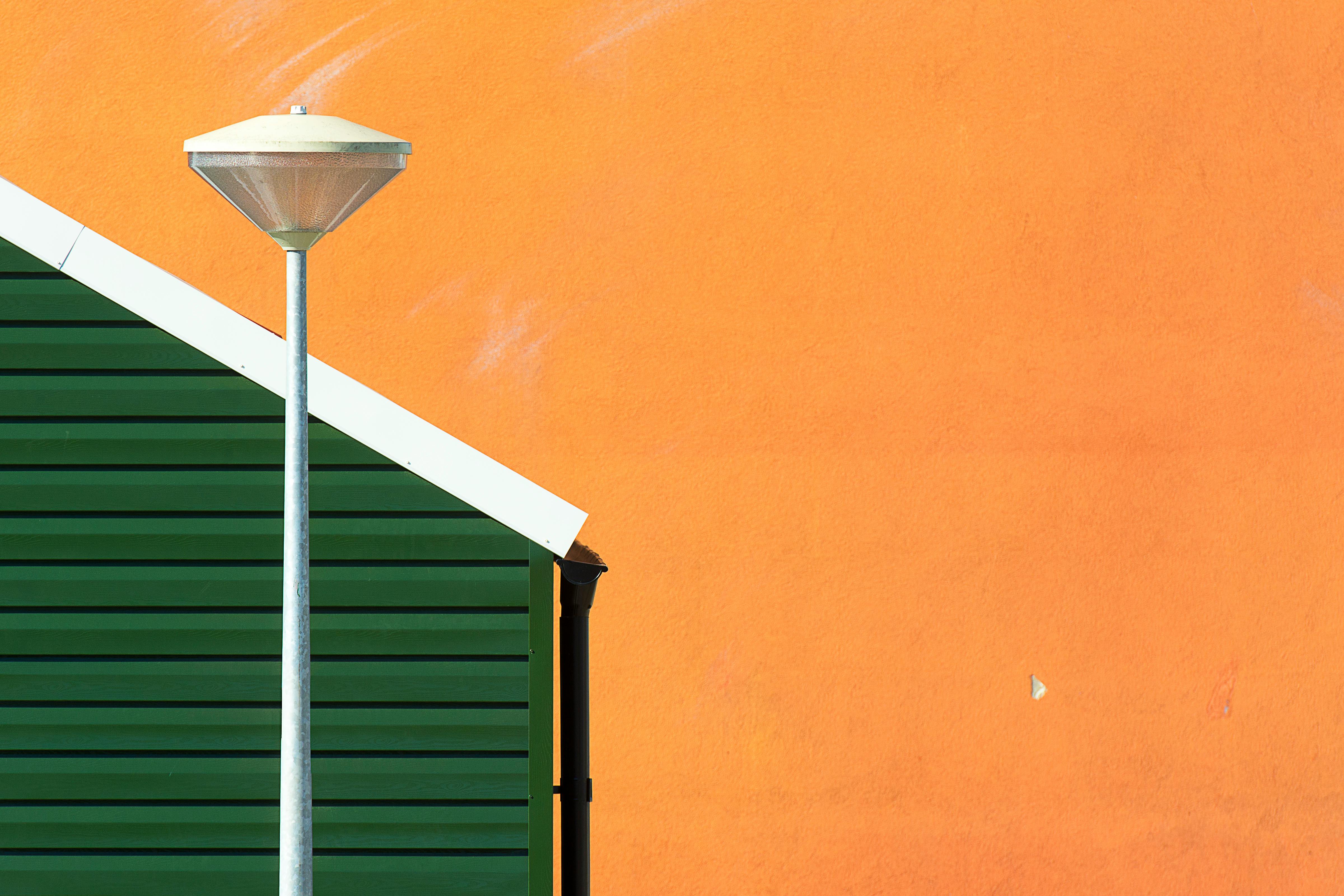 Gray Lamp Post Beside the Orange Wall · Free Stock Photo
