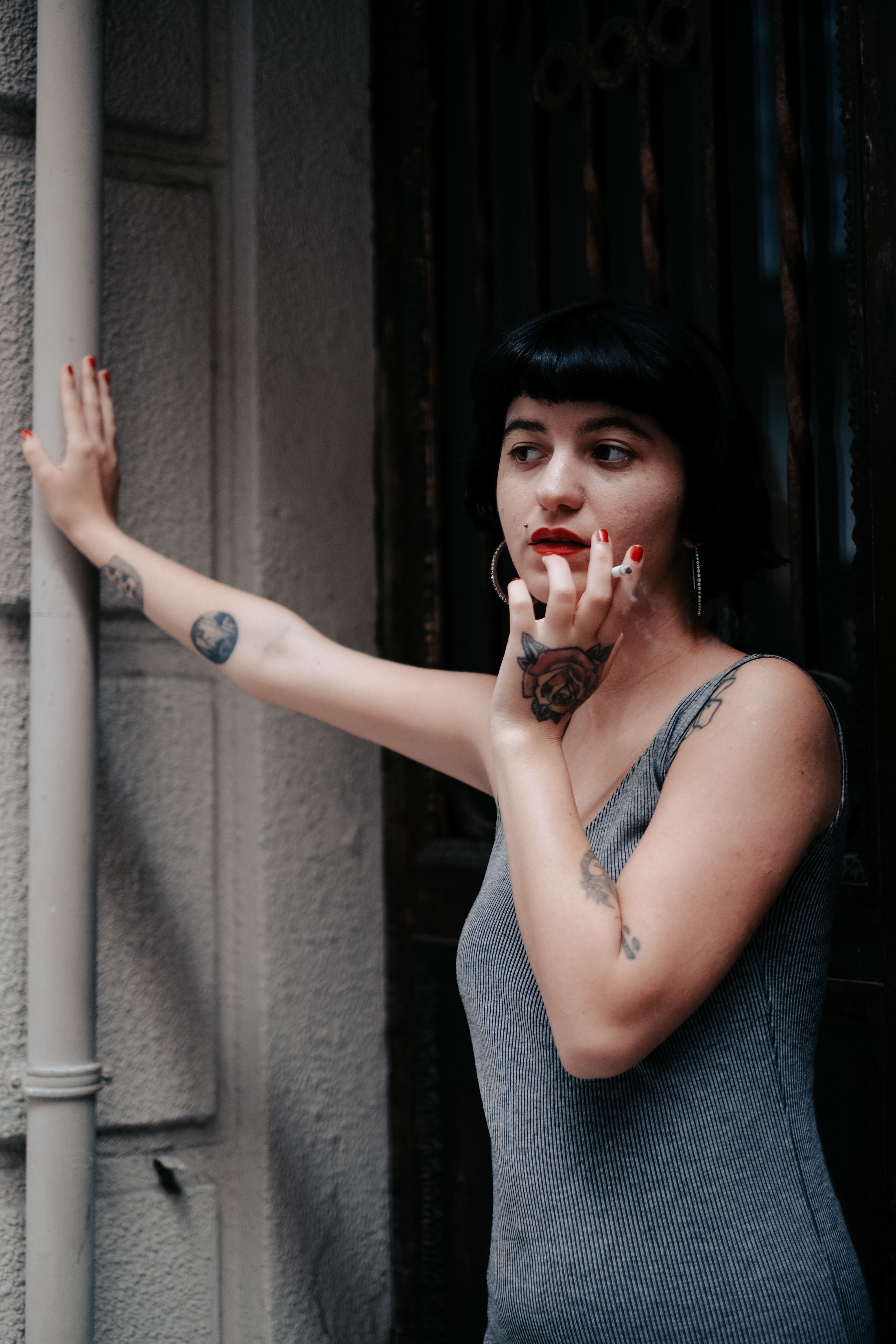 A Woman in Black Long Sleeves Smoking Cigarette · Free Stock Photo