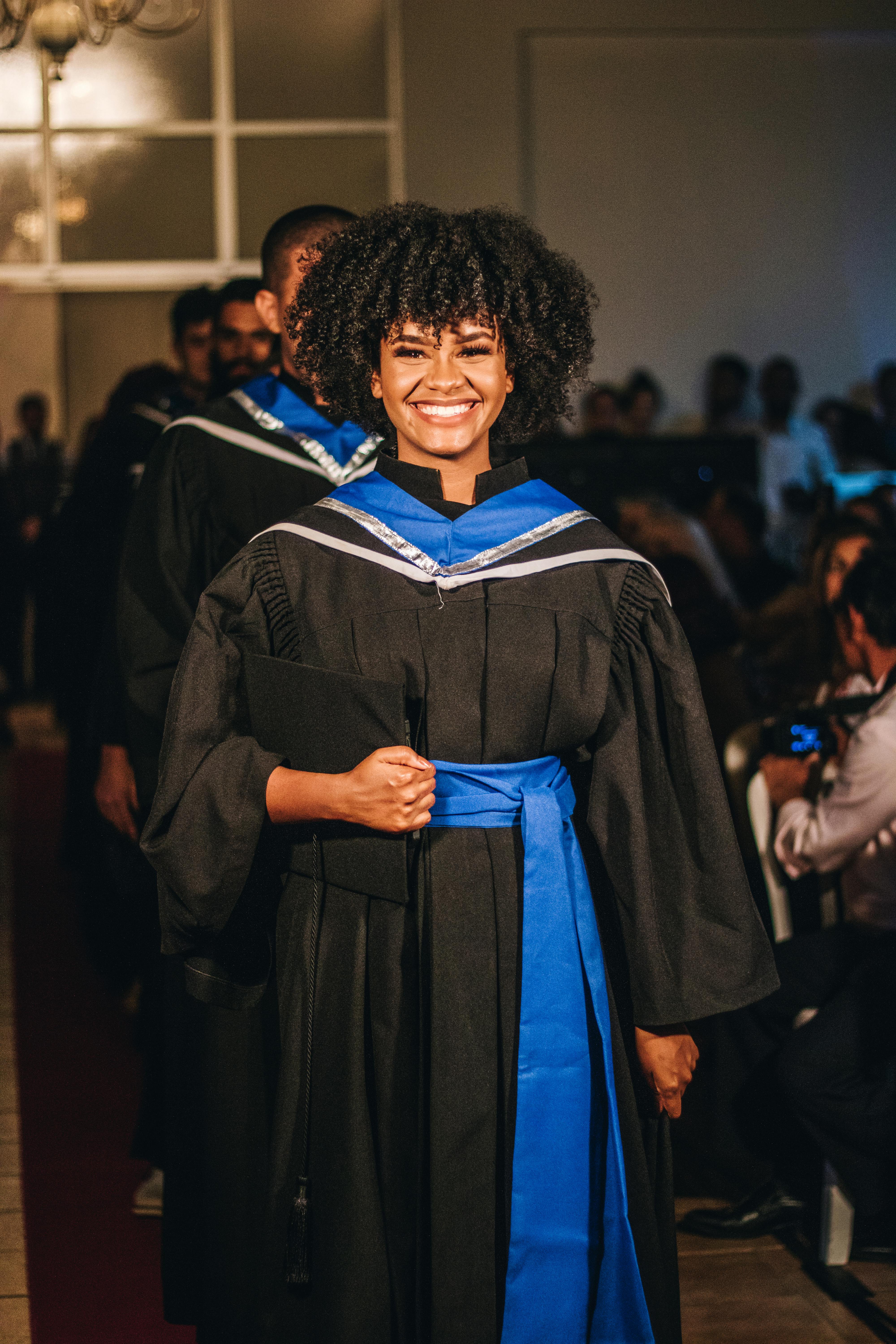 Woman in Academic Dress Smiling · Free Stock Photo
