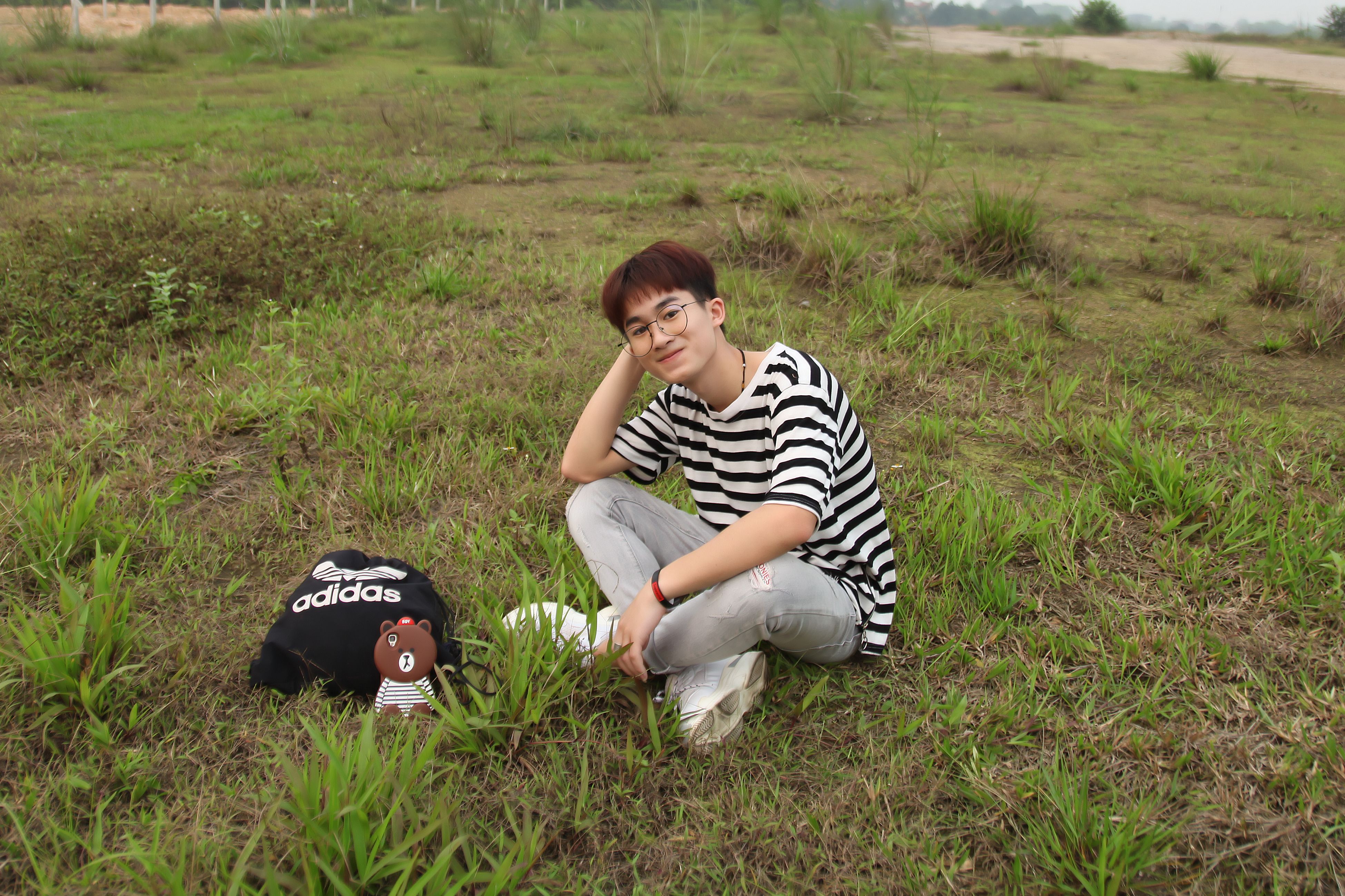 Young Man Lying on the Grass Field and Holding His Arm over His Eyes ...