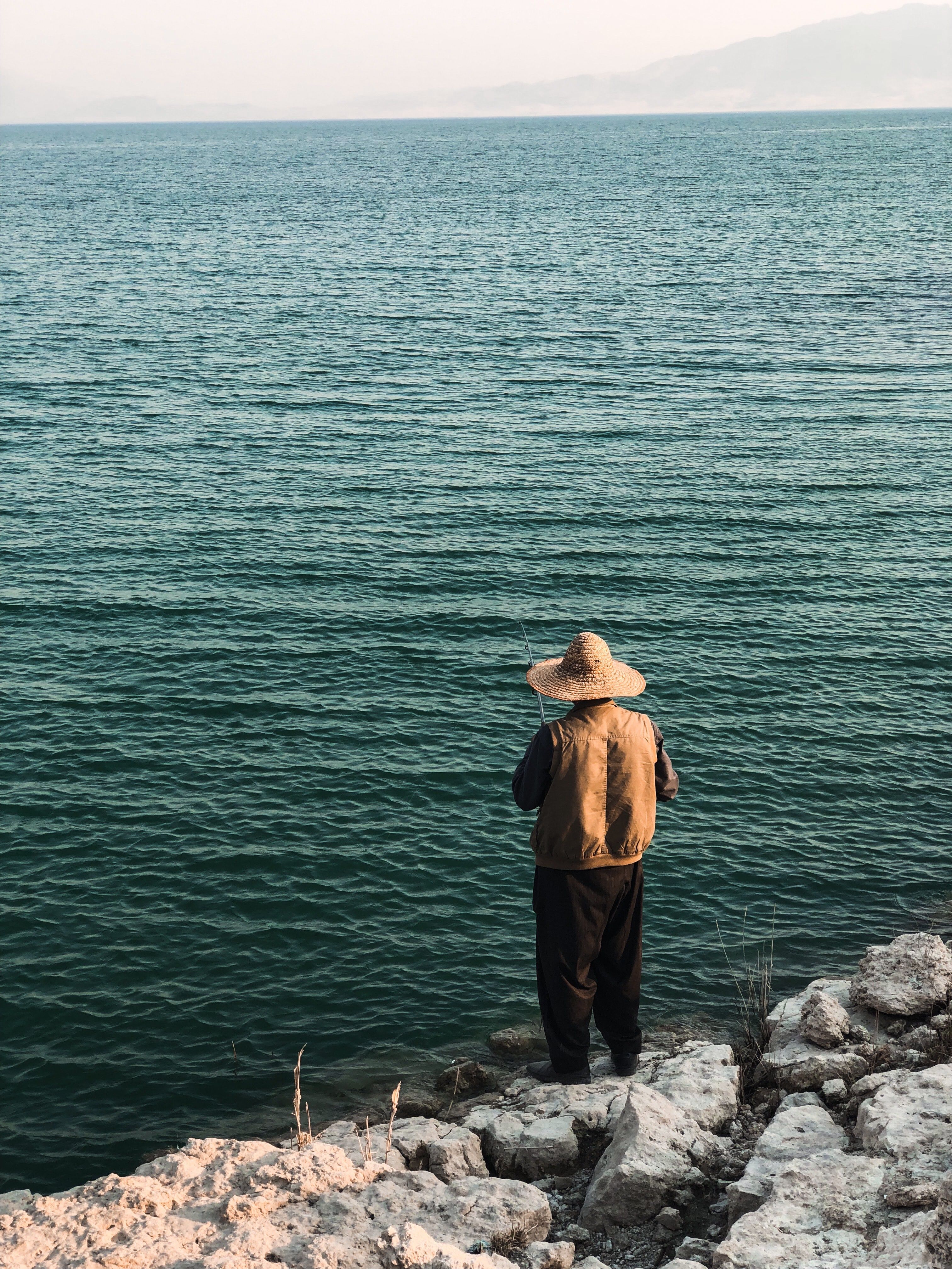Fisherman Fishing on Sea Shore · Free Stock Photo