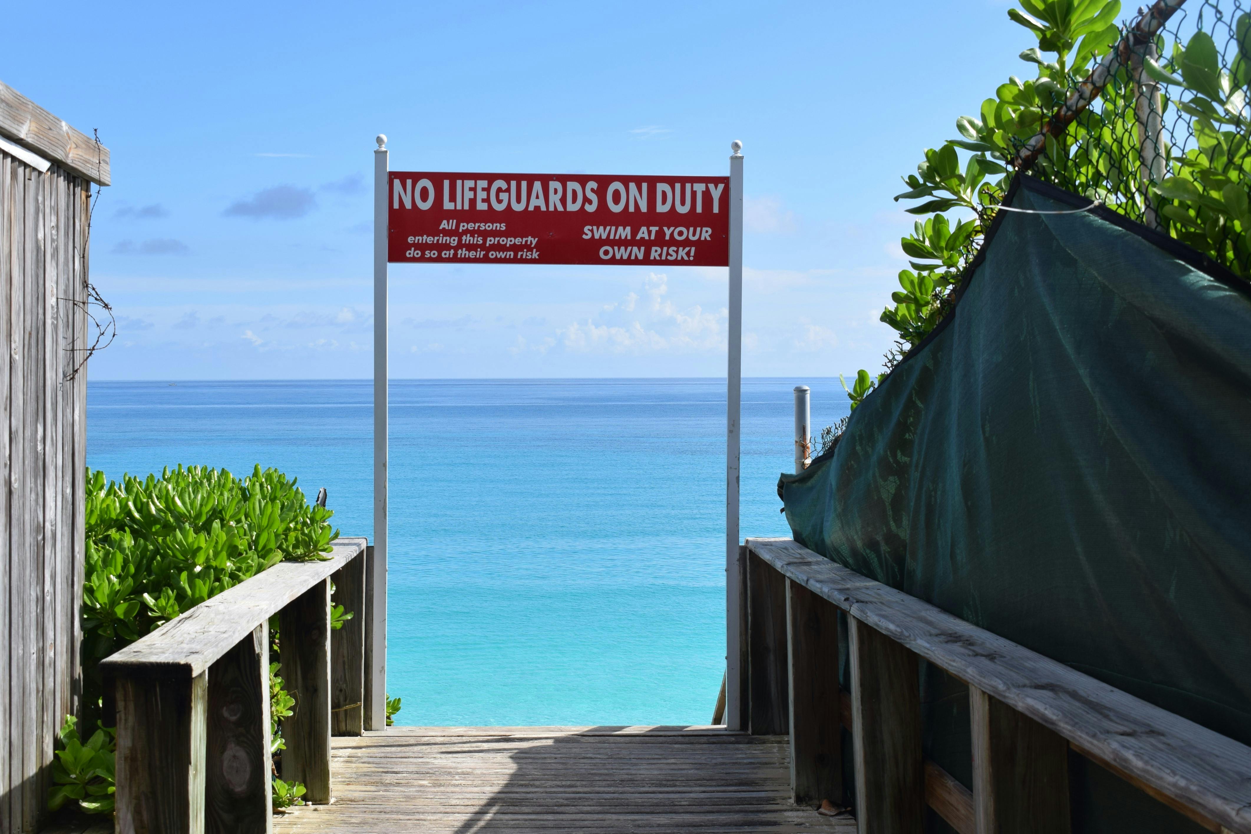 A No Lifeguards on Duty Sign at a Beach Entrance · Free Stock Photo