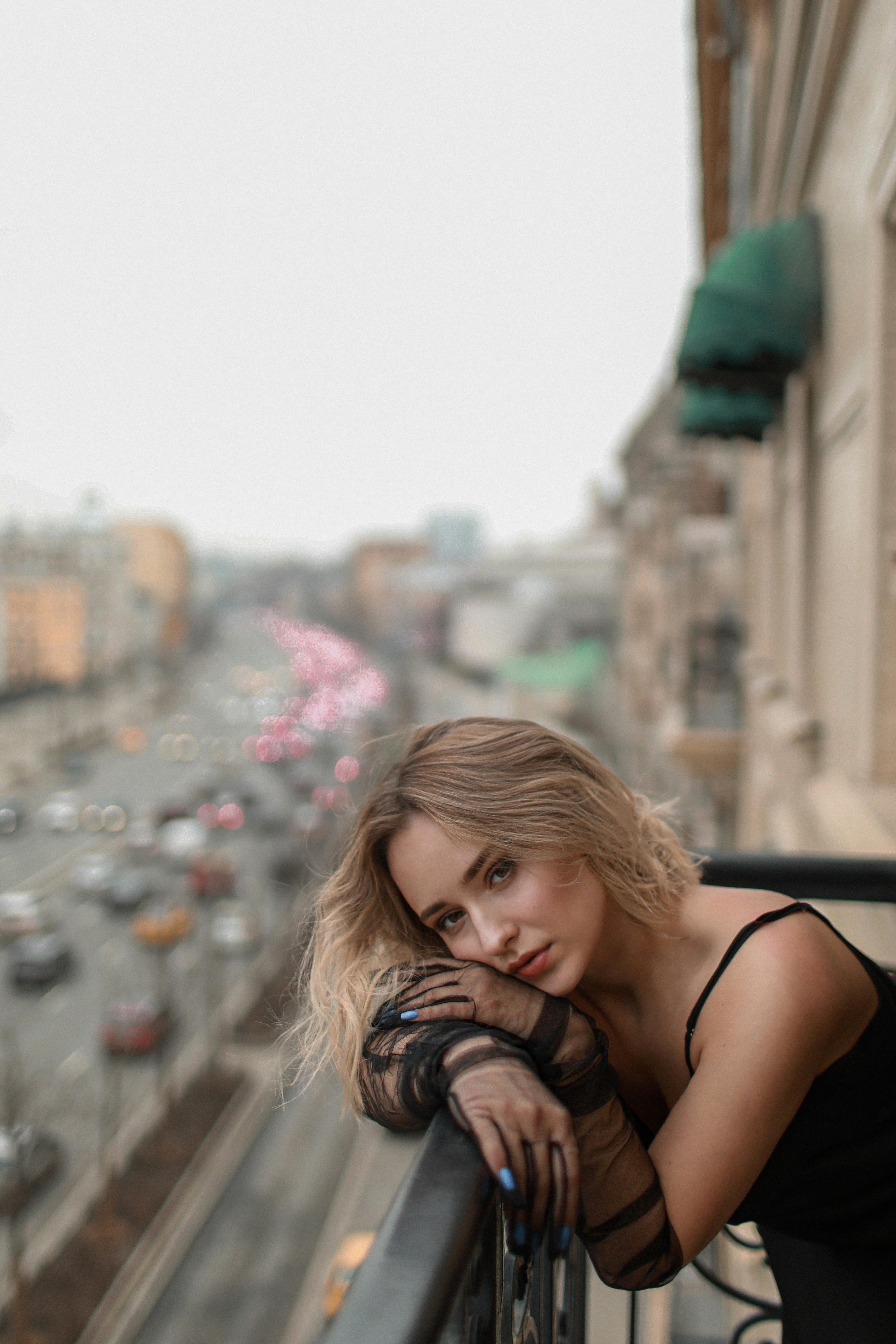 A Woman Leaning on Railing · Free Stock Photo