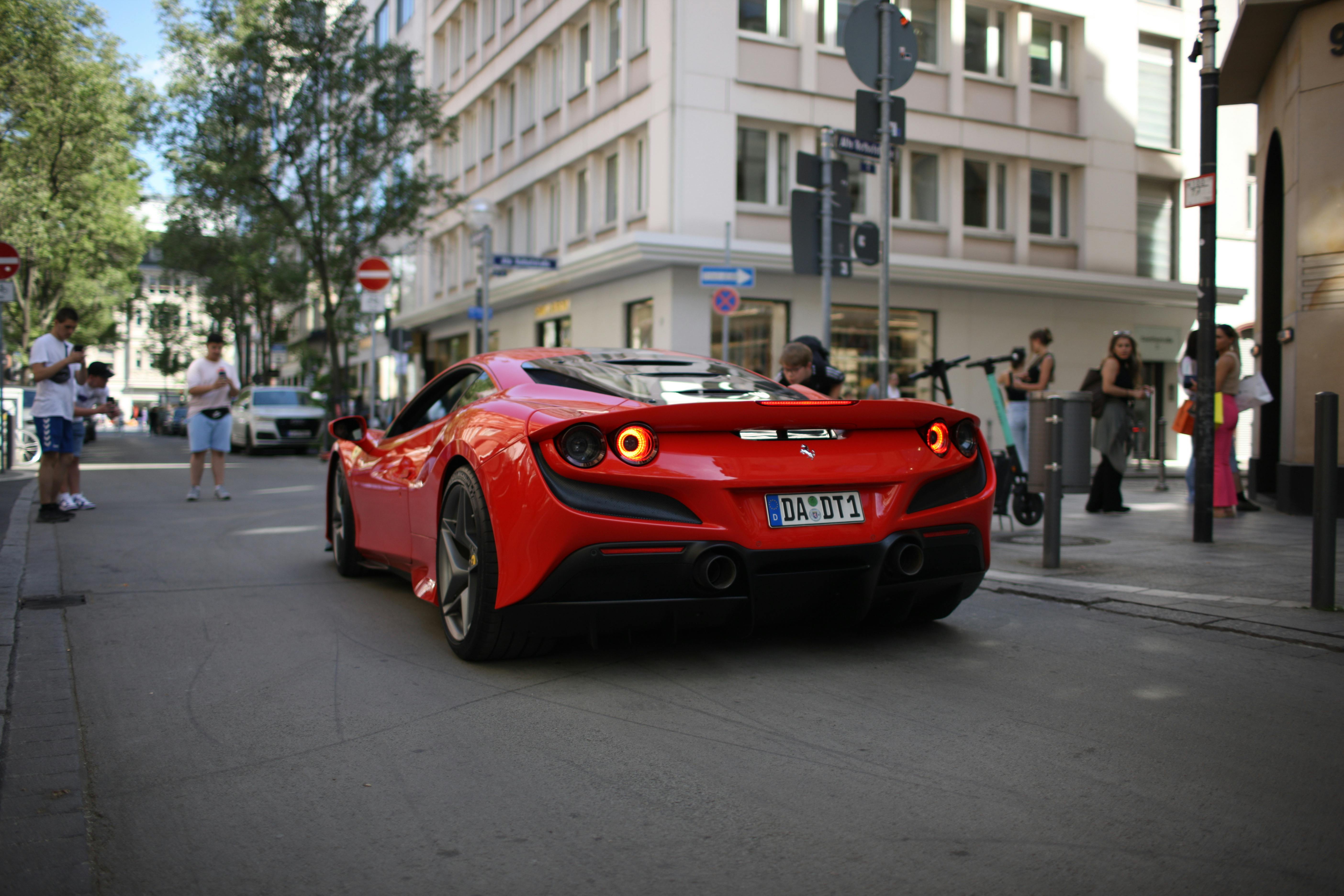 People Taking Photos of Red Ferrari 8 on the Road · Free Stock Photo