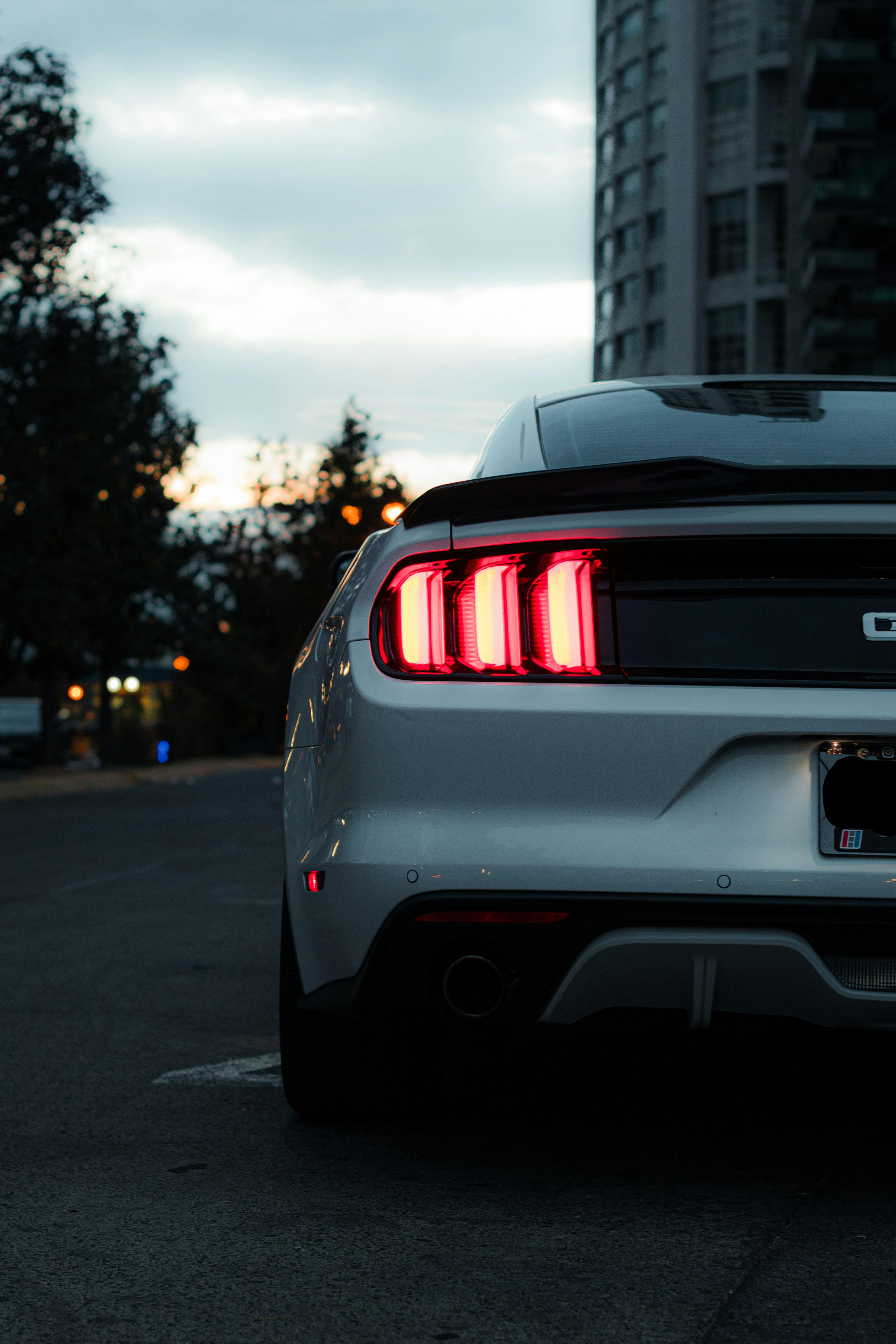 Black Ford Mustang Parked on an Asphalt Road · Free Stock Photo