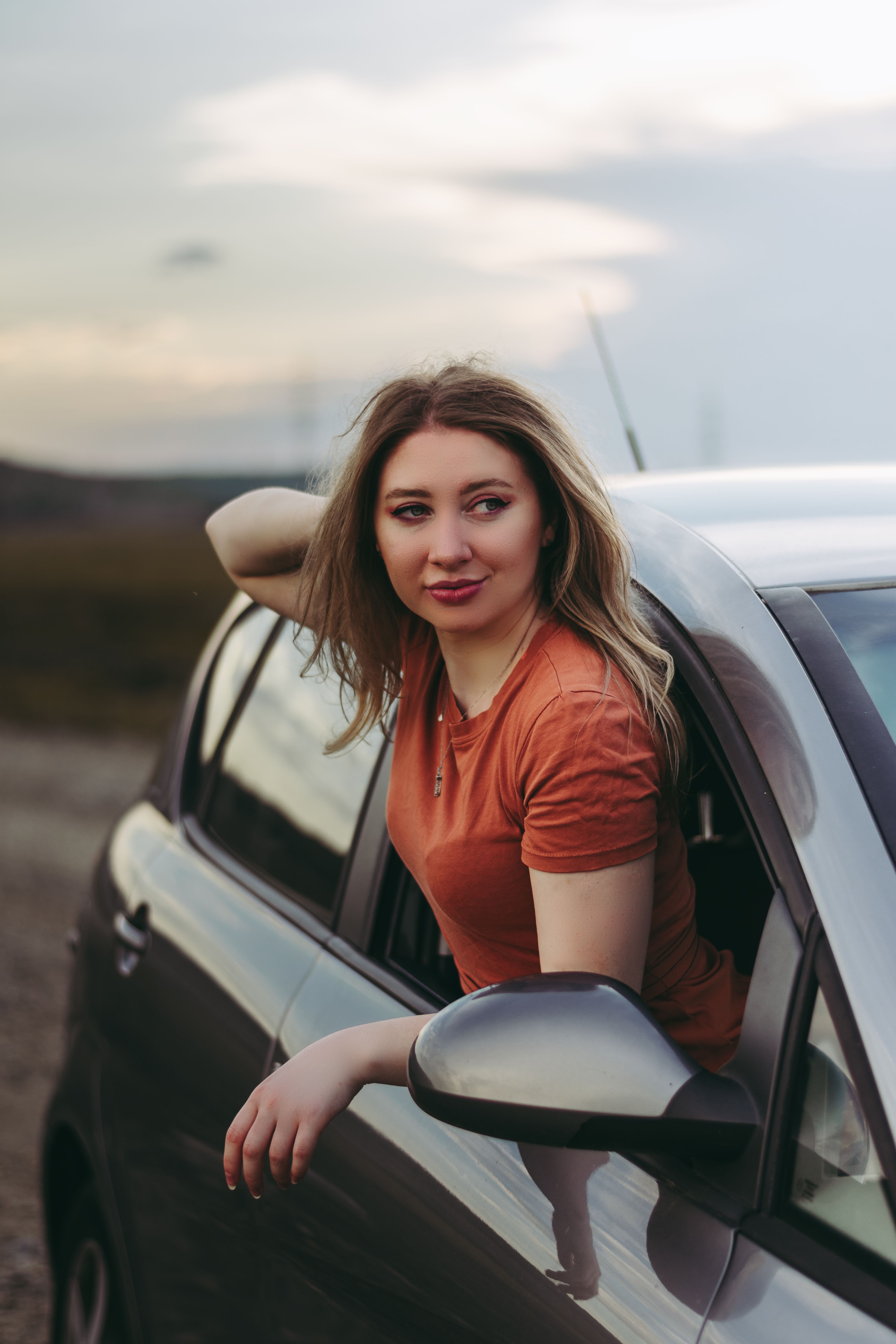 Woman in Sweater Inside a Car · Free Stock Photo