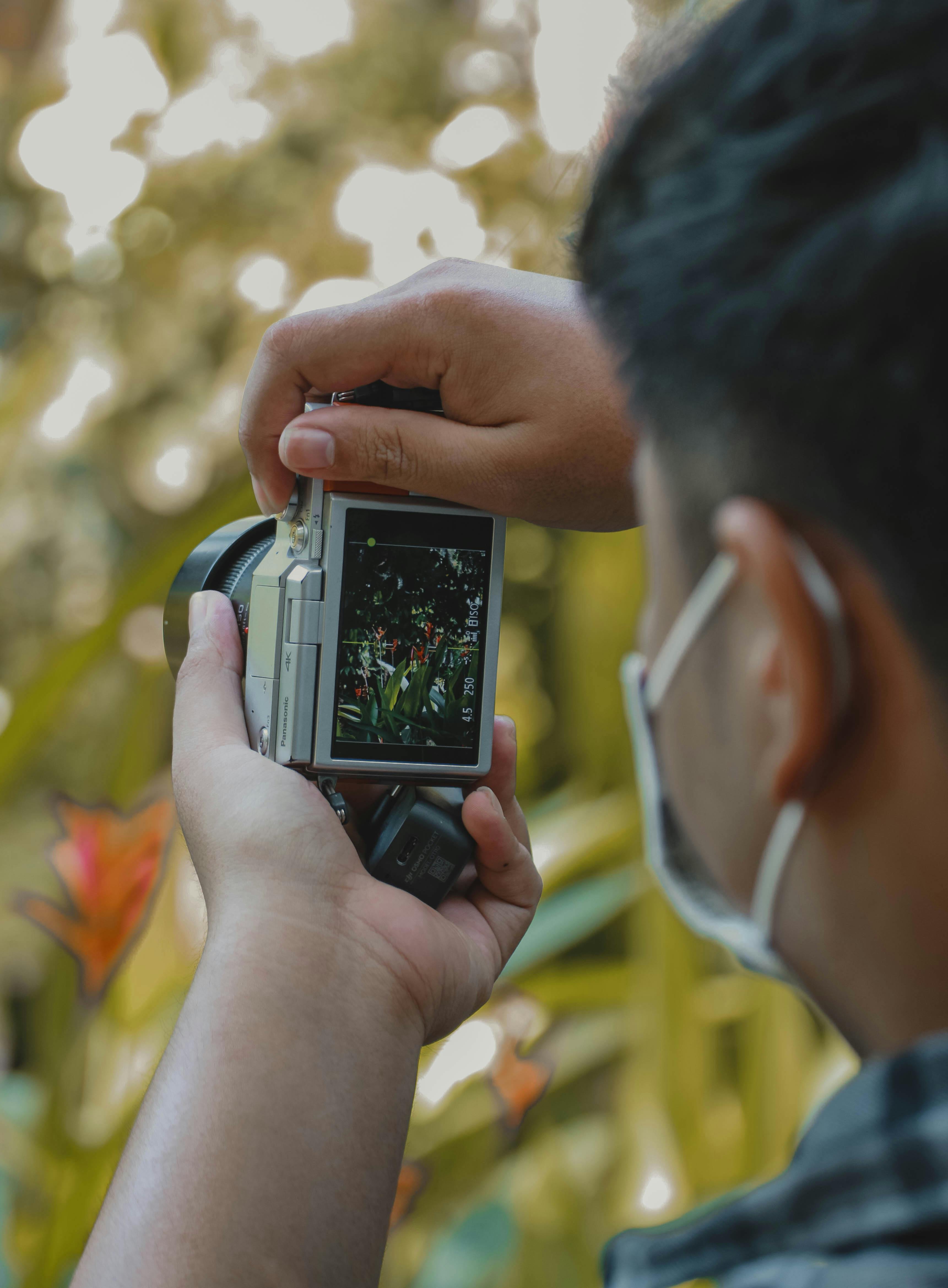 A Man Taking Photo of a Man in Traditional Clothing · Free Stock Photo