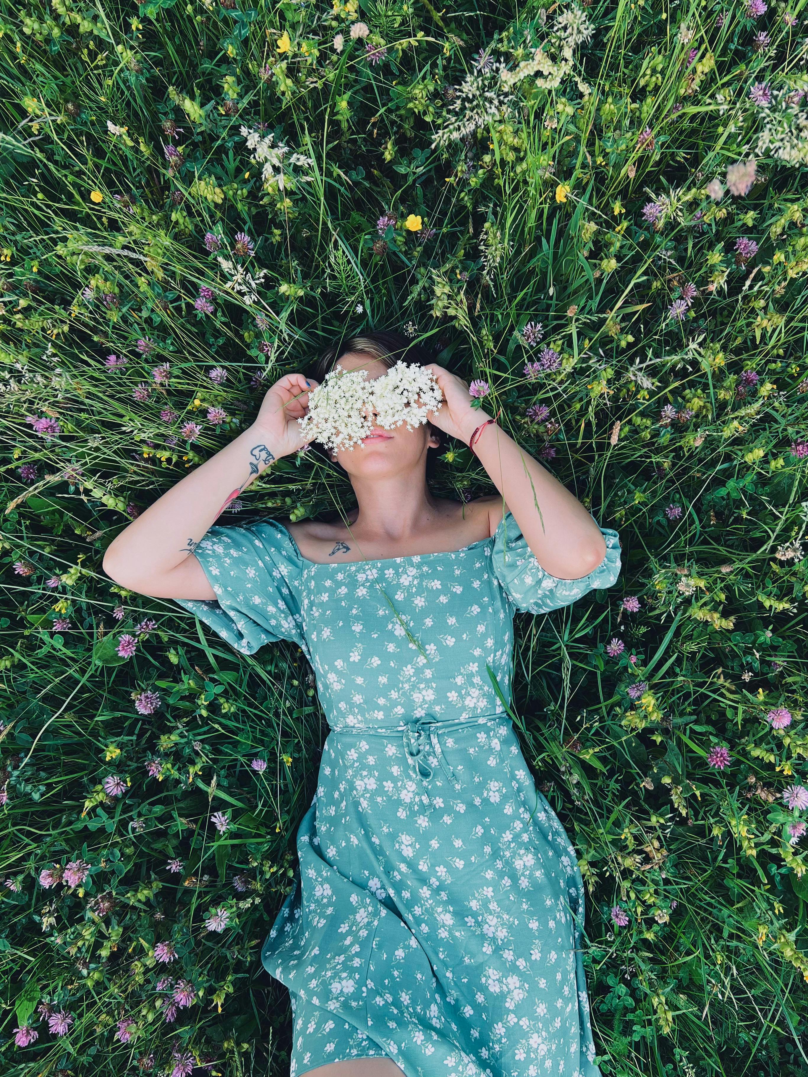 A Woman Covering her Face with Flowers · Free Stock Photo