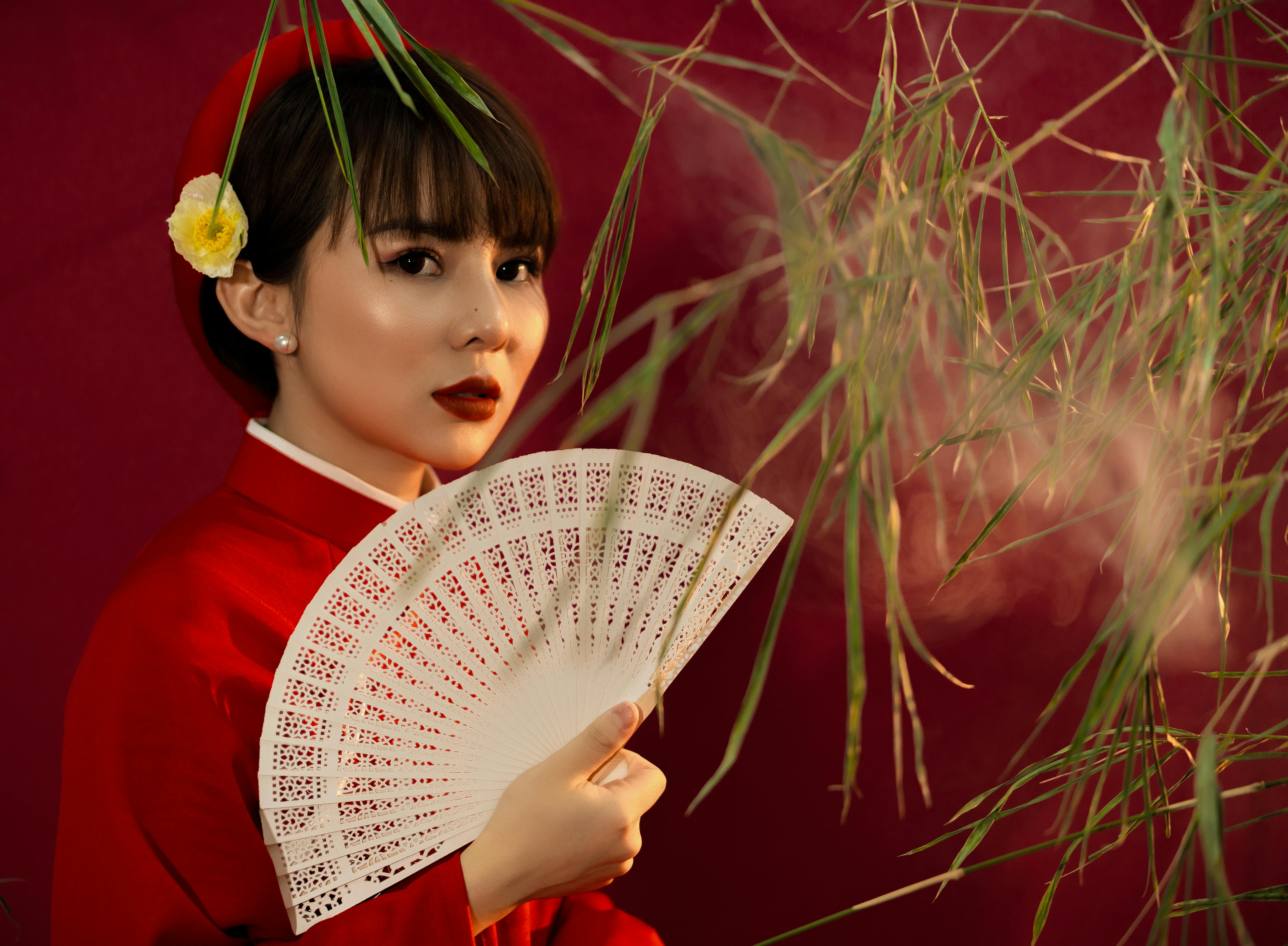 Photo of a Teenage Girl Holding a Hand Fan · Free Stock Photo