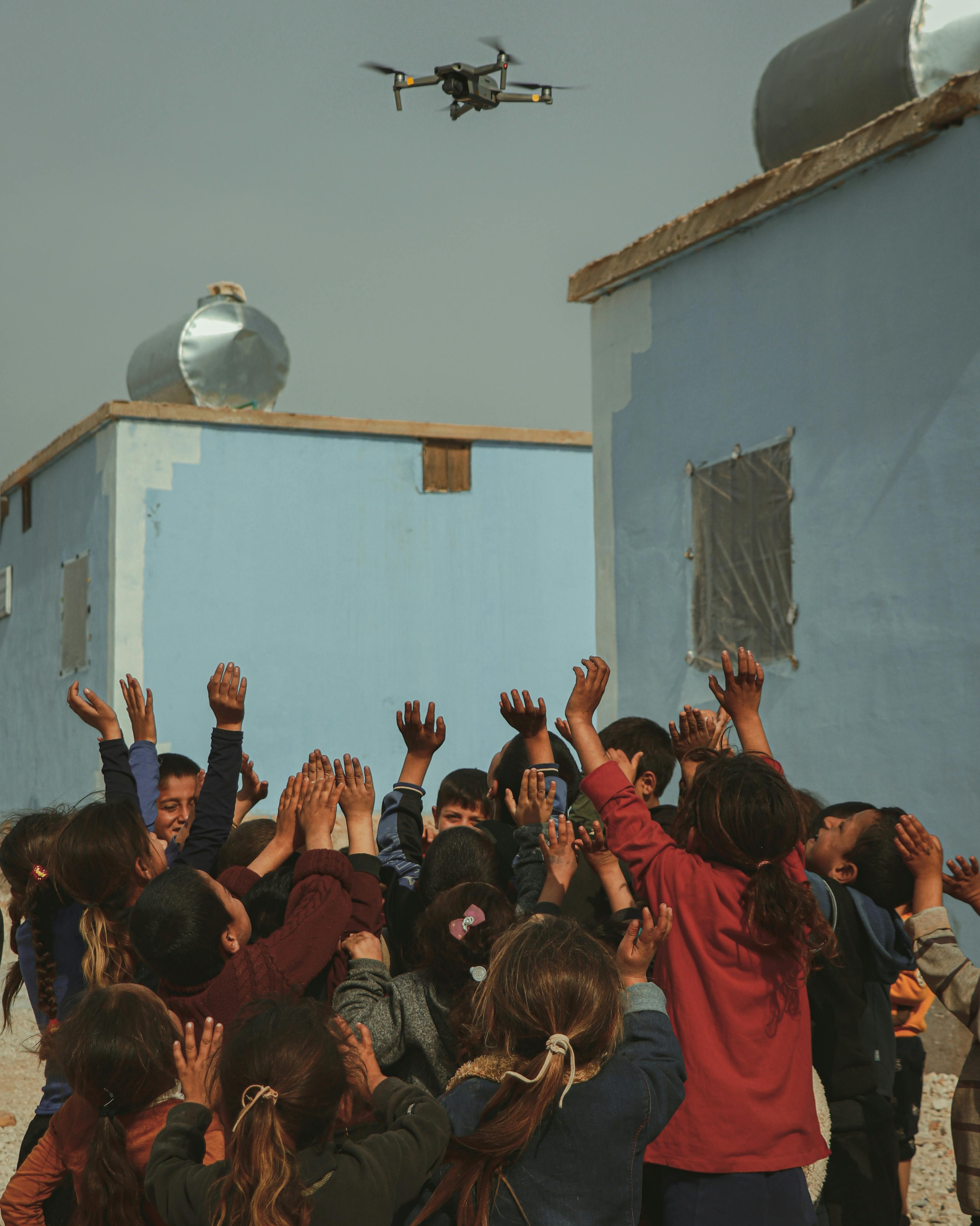 Group of Children Cheering with Their Hands in the Air · Free Stock Photo