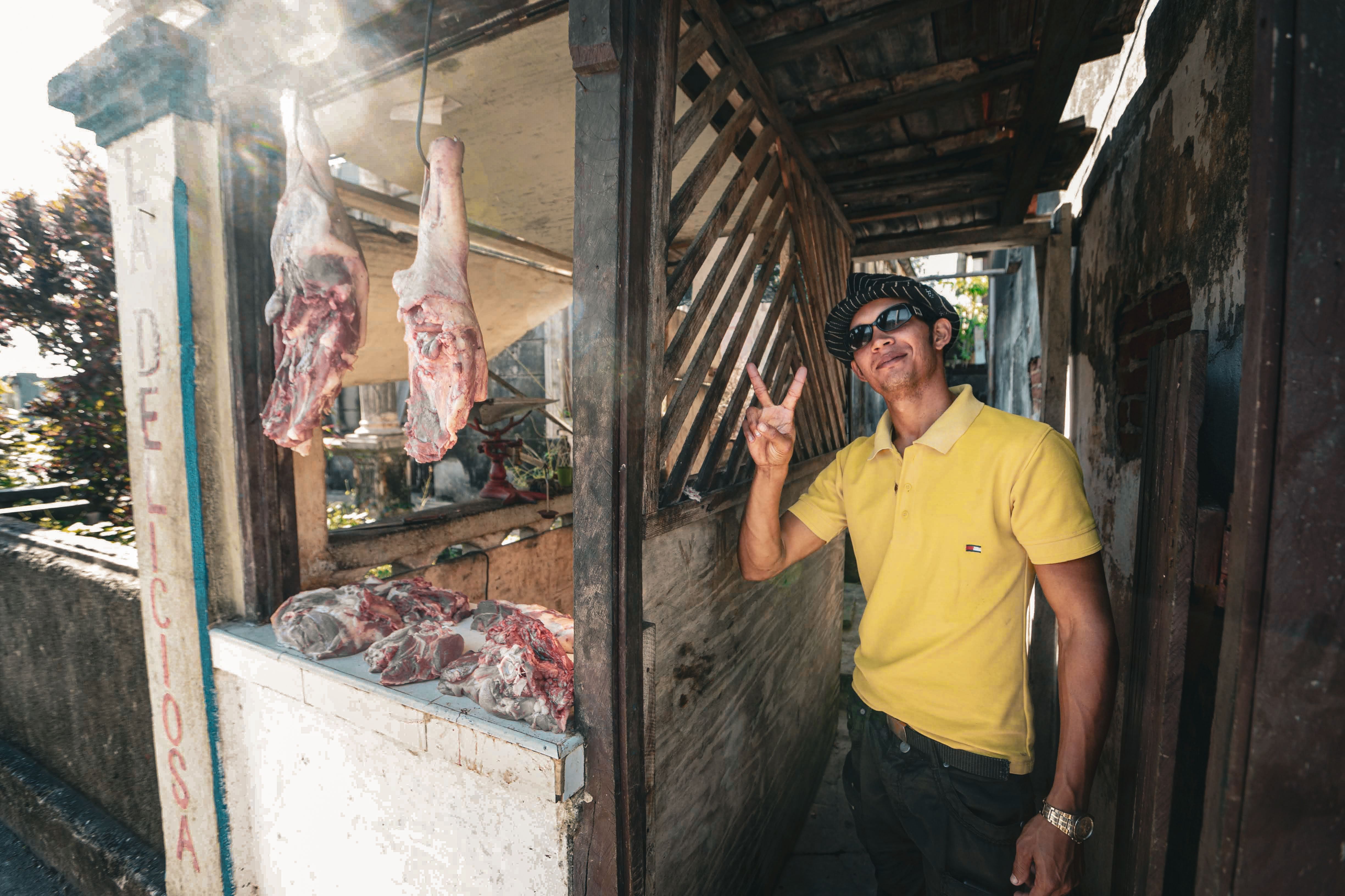 Man in Yellow Shirt Posing Next to Smoking Meat · Free Stock Photo