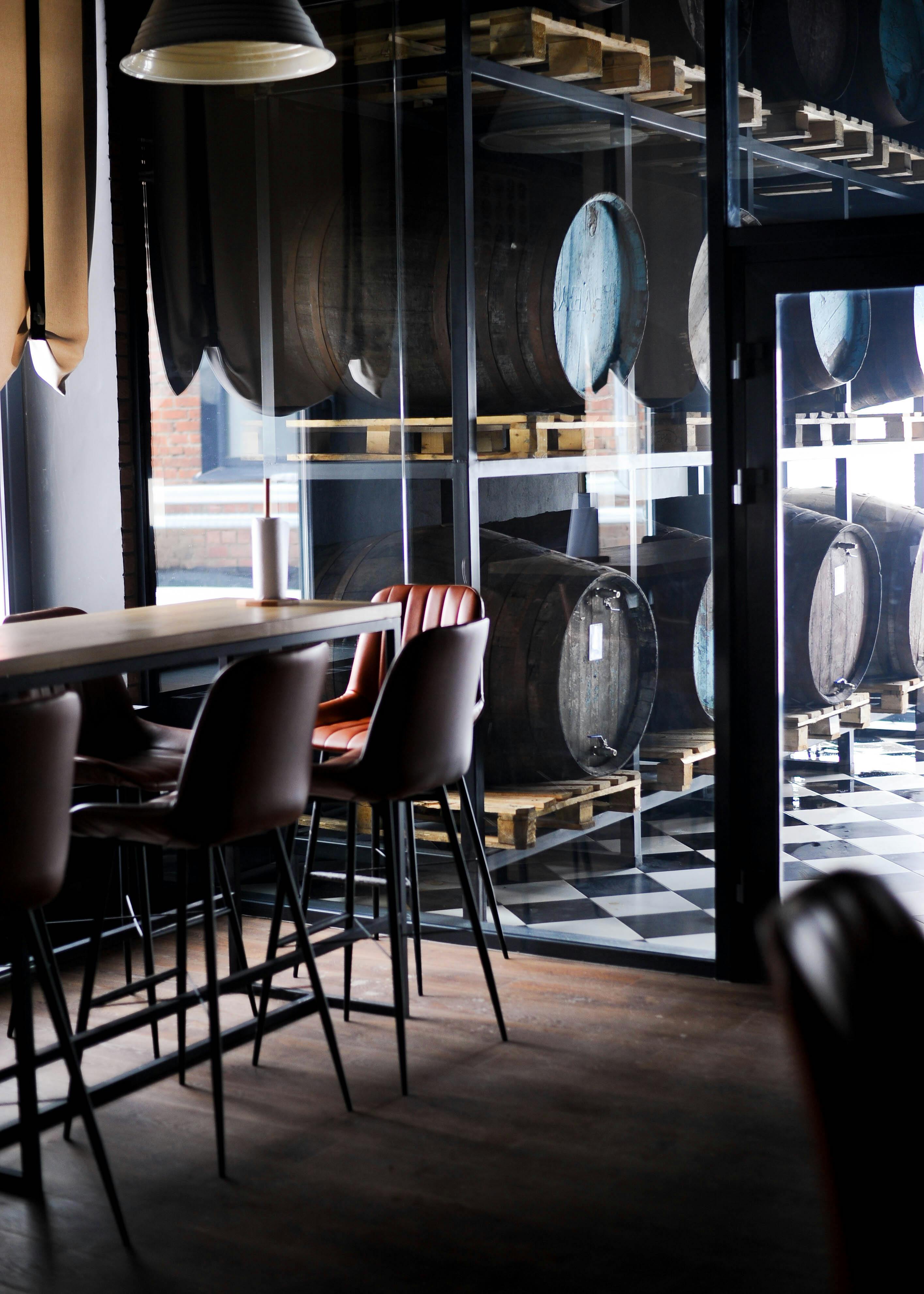 Kegs, Chairs and Table in Building · Free Stock Photo