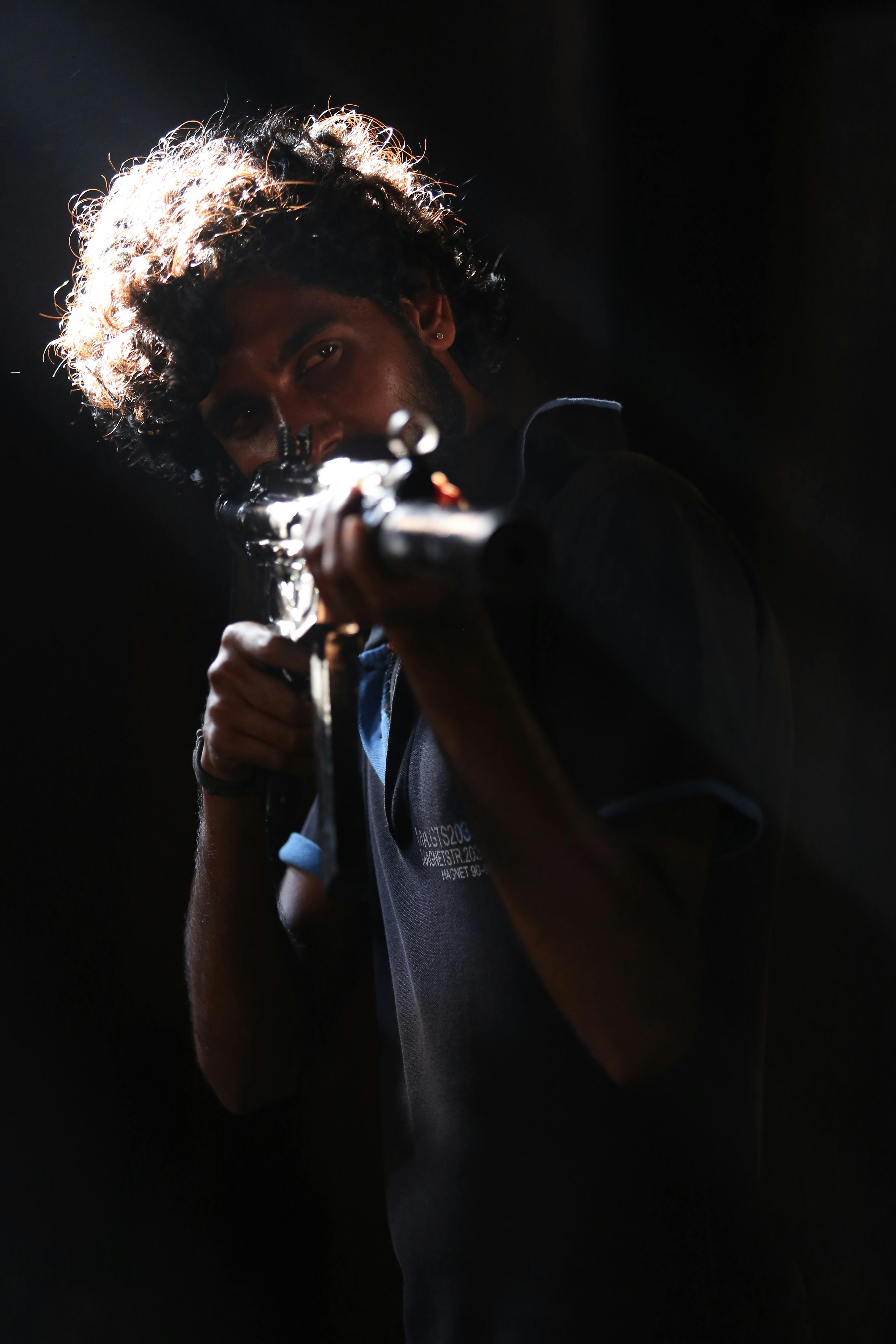 Black Sniper Rifle on Gray Table · Free Stock Photo