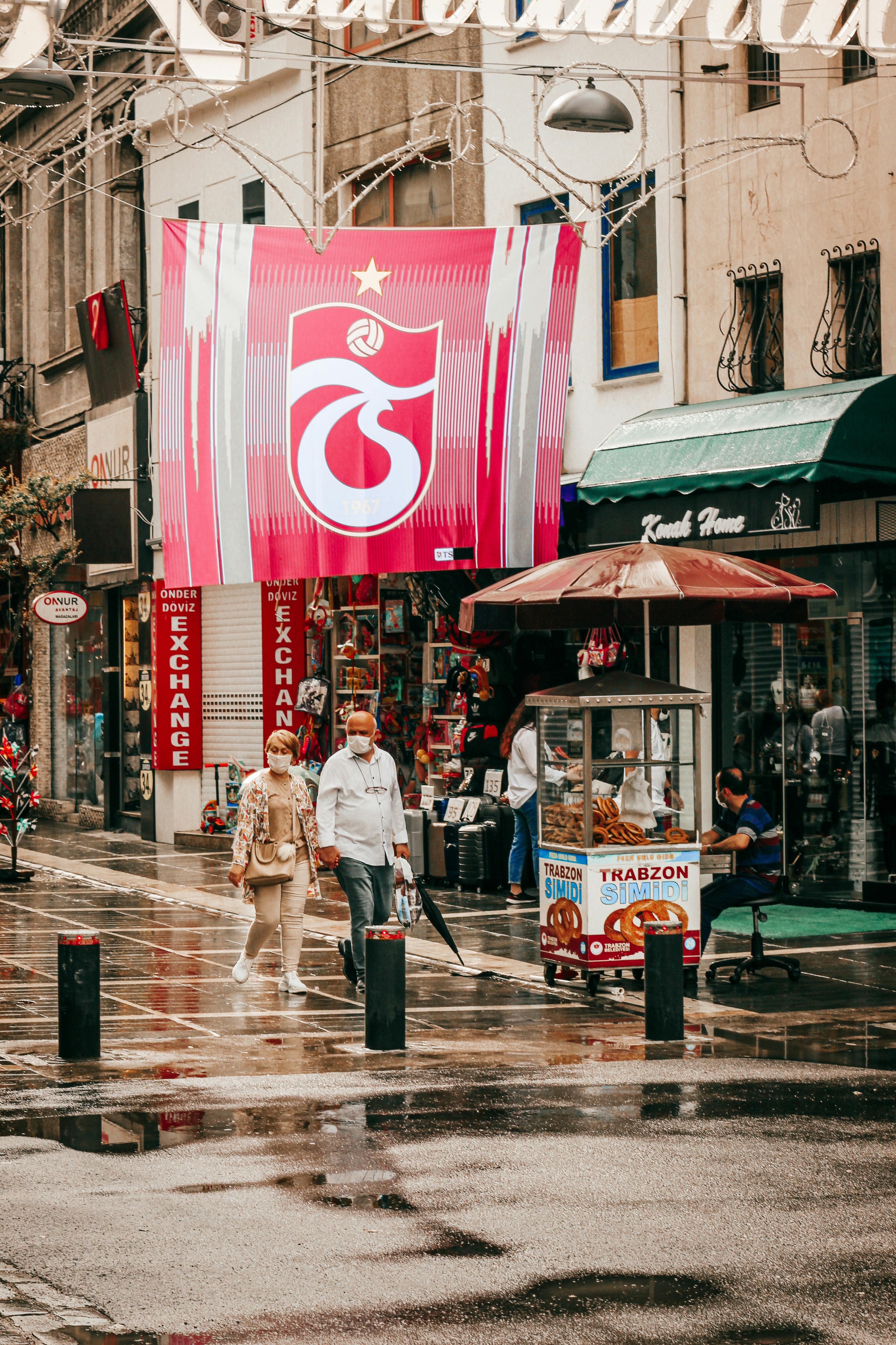 Rainy Street Scene with Trabzon Flag and People · Free Stock Photo