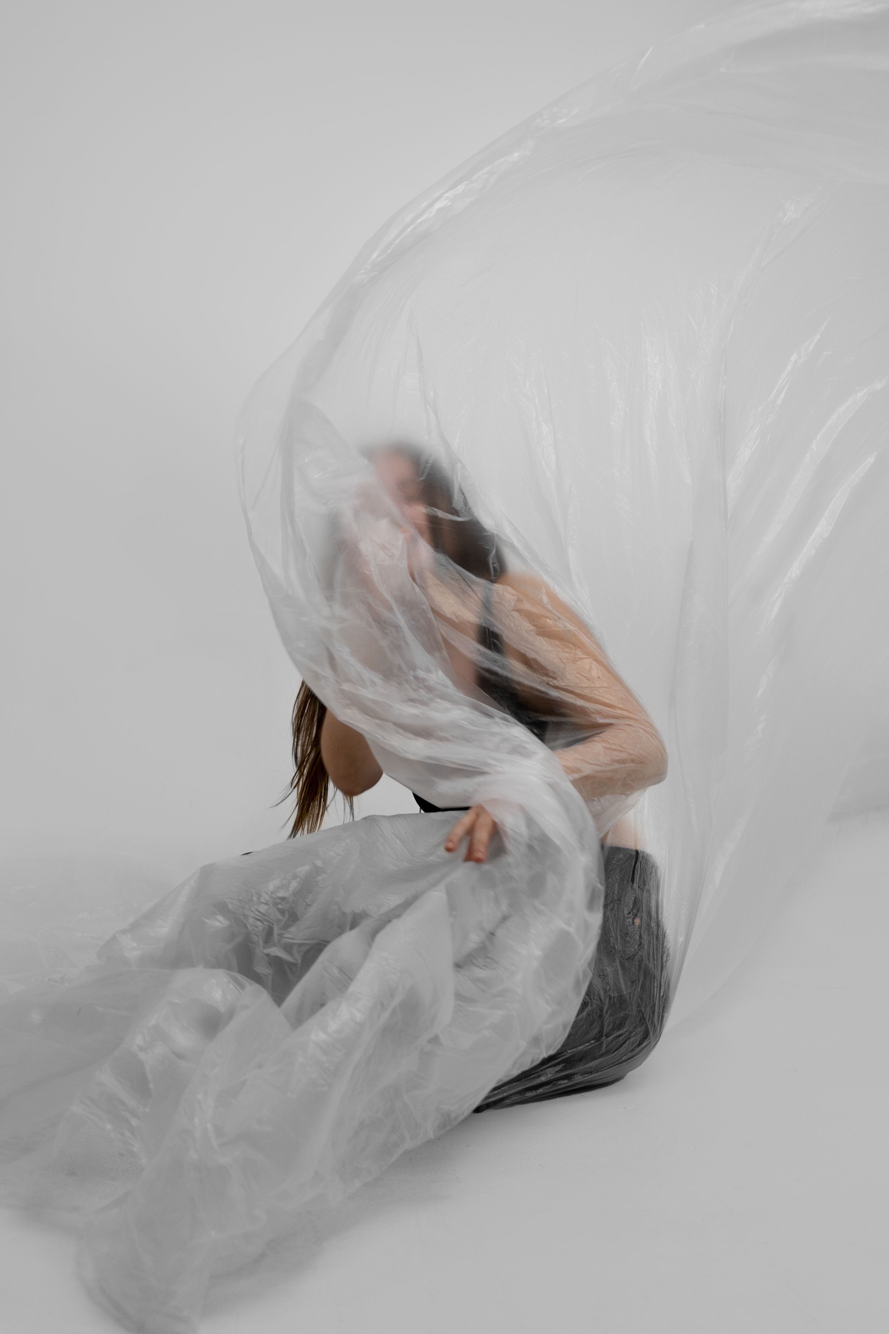 A Woman in White Outfit Sitting on Transparent Plastic · Free Stock Photo
