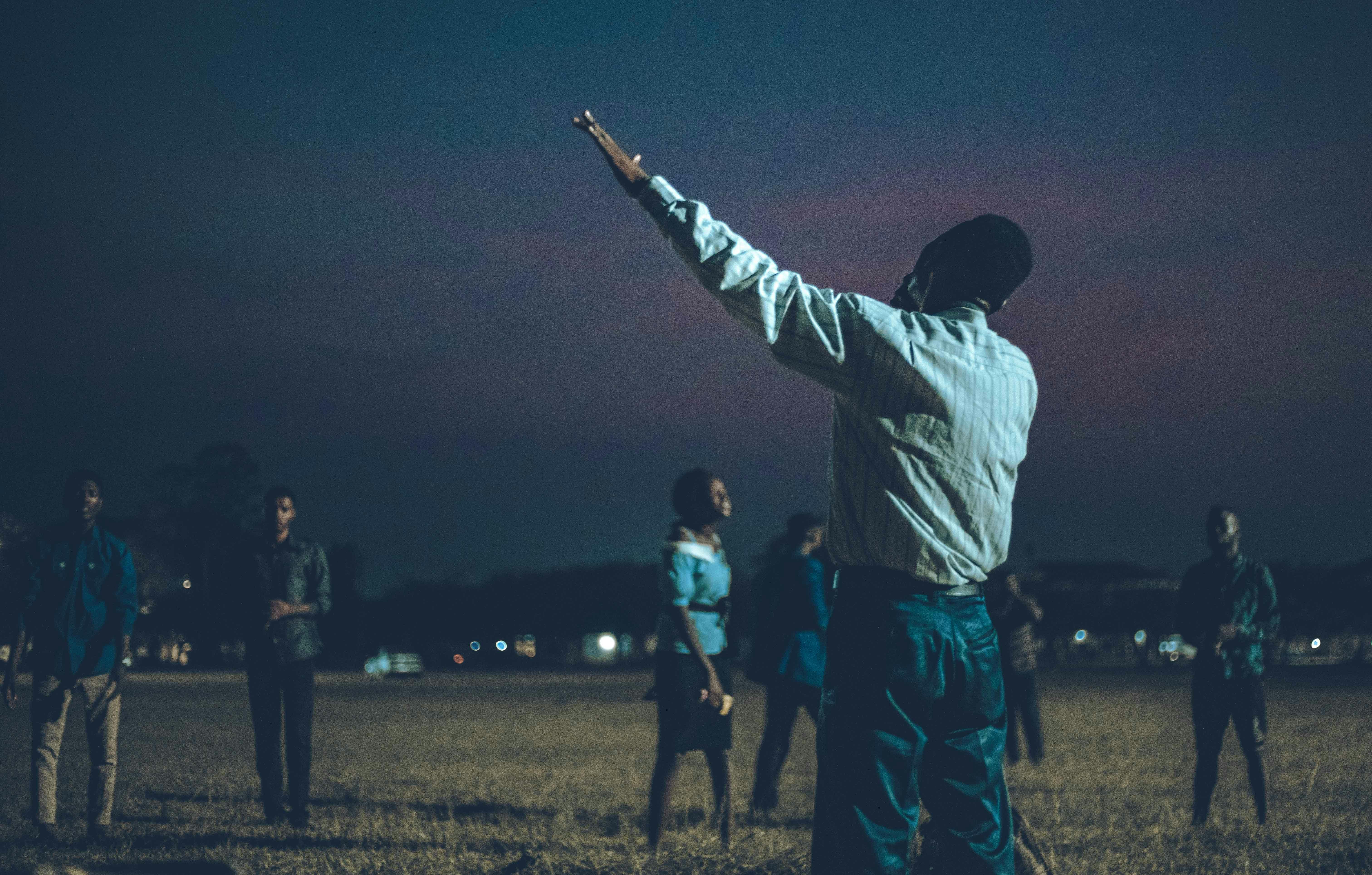 People Praying on an Open Field During Night Timer · Free Stock Photo
