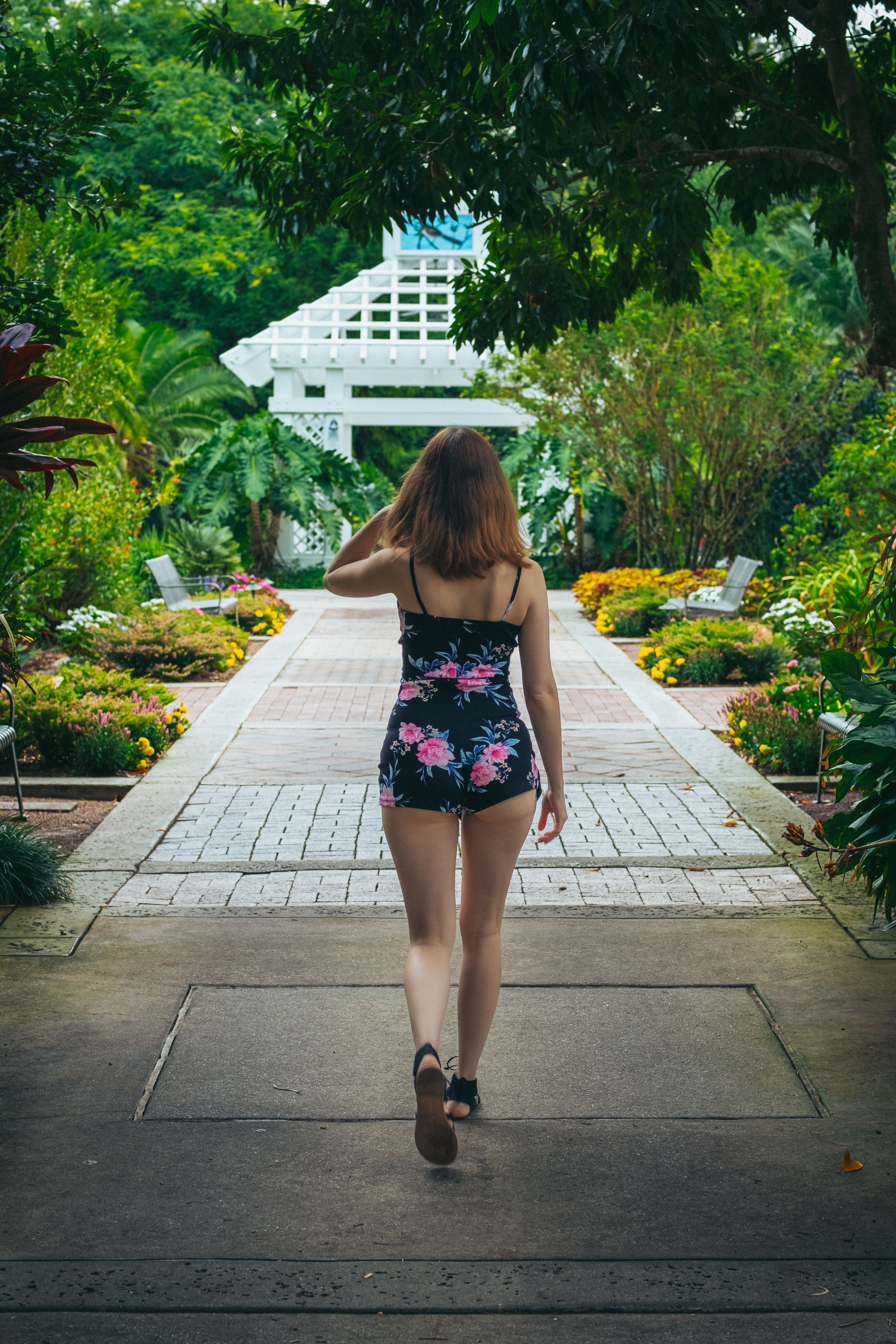 Back View of a Woman in a Floral Romper Walking · Free Stock Photo