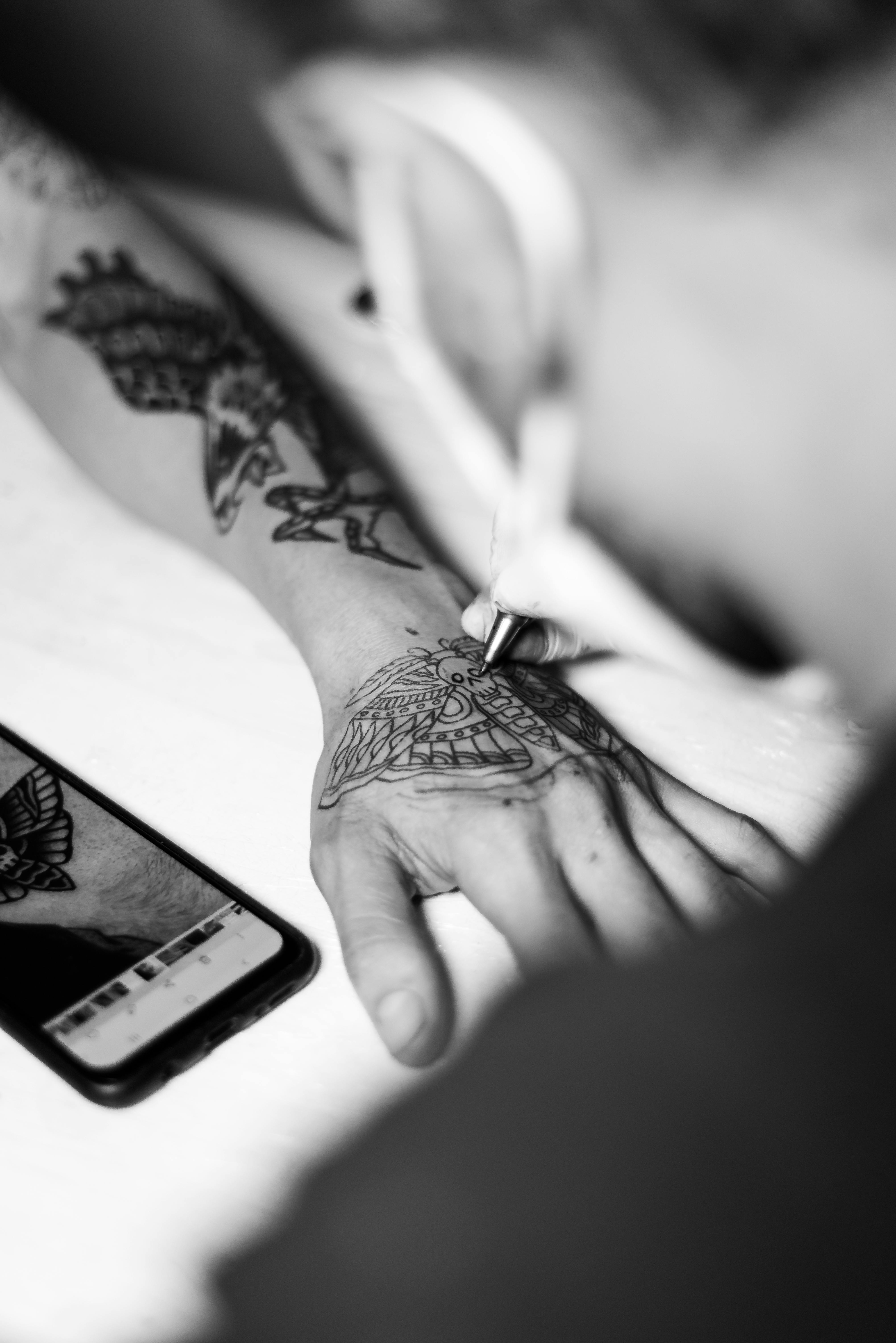 A Man Tattooing a Person · Free Stock Photo