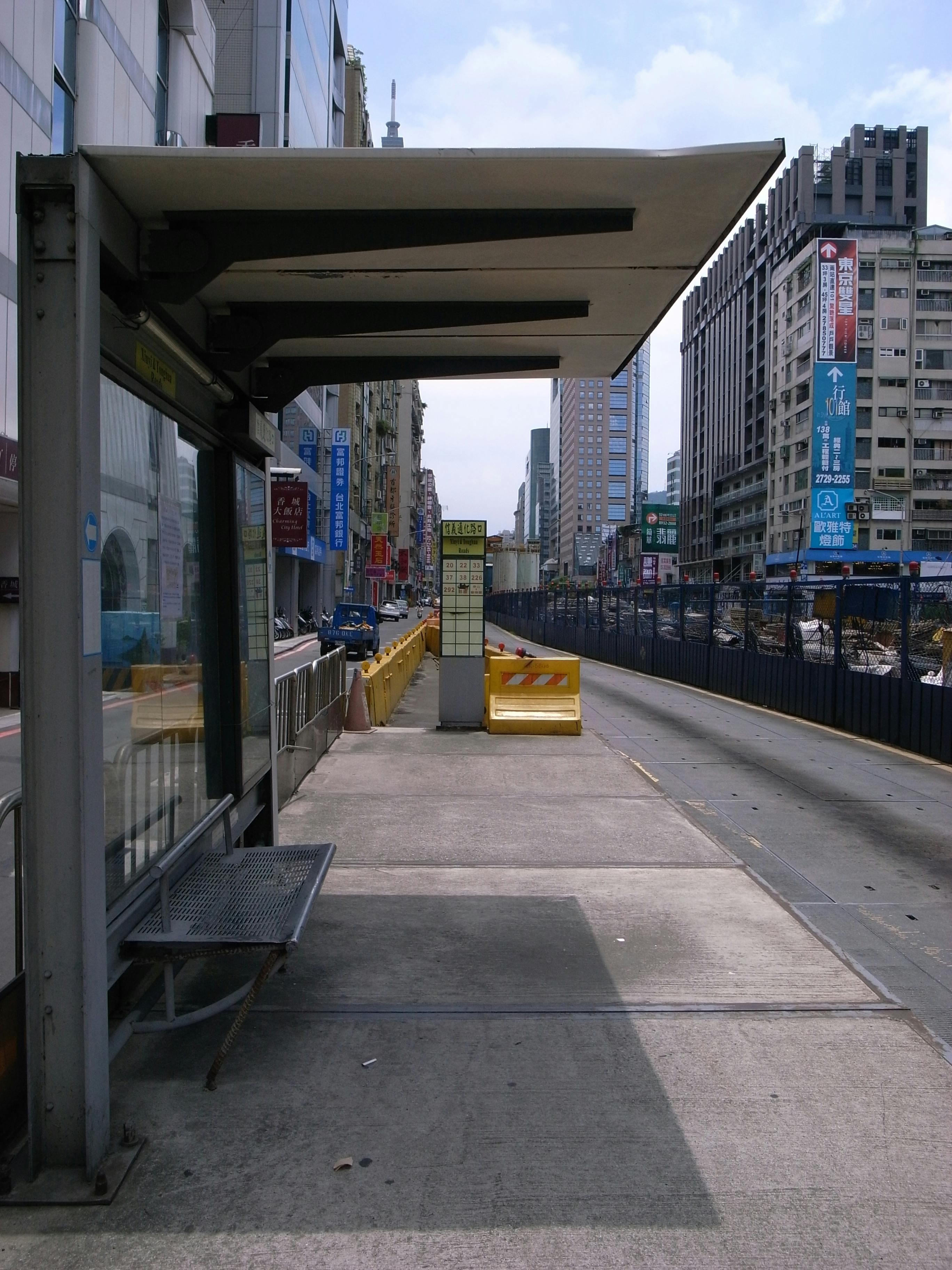 Waiting Shed on the Side of the Road Near City Buildings · Free Stock Photo