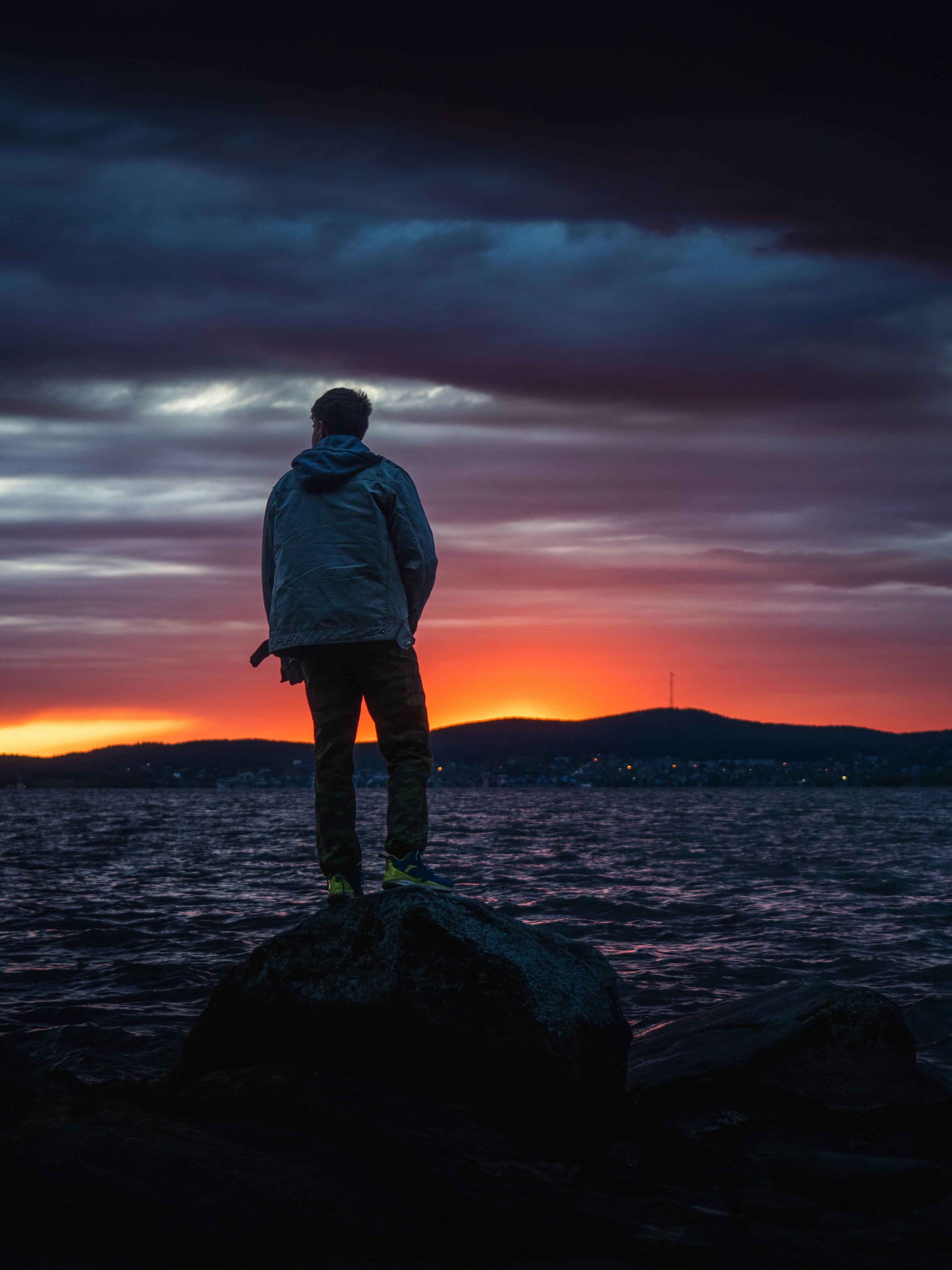 Person Standing on a Rock · Free Stock Photo