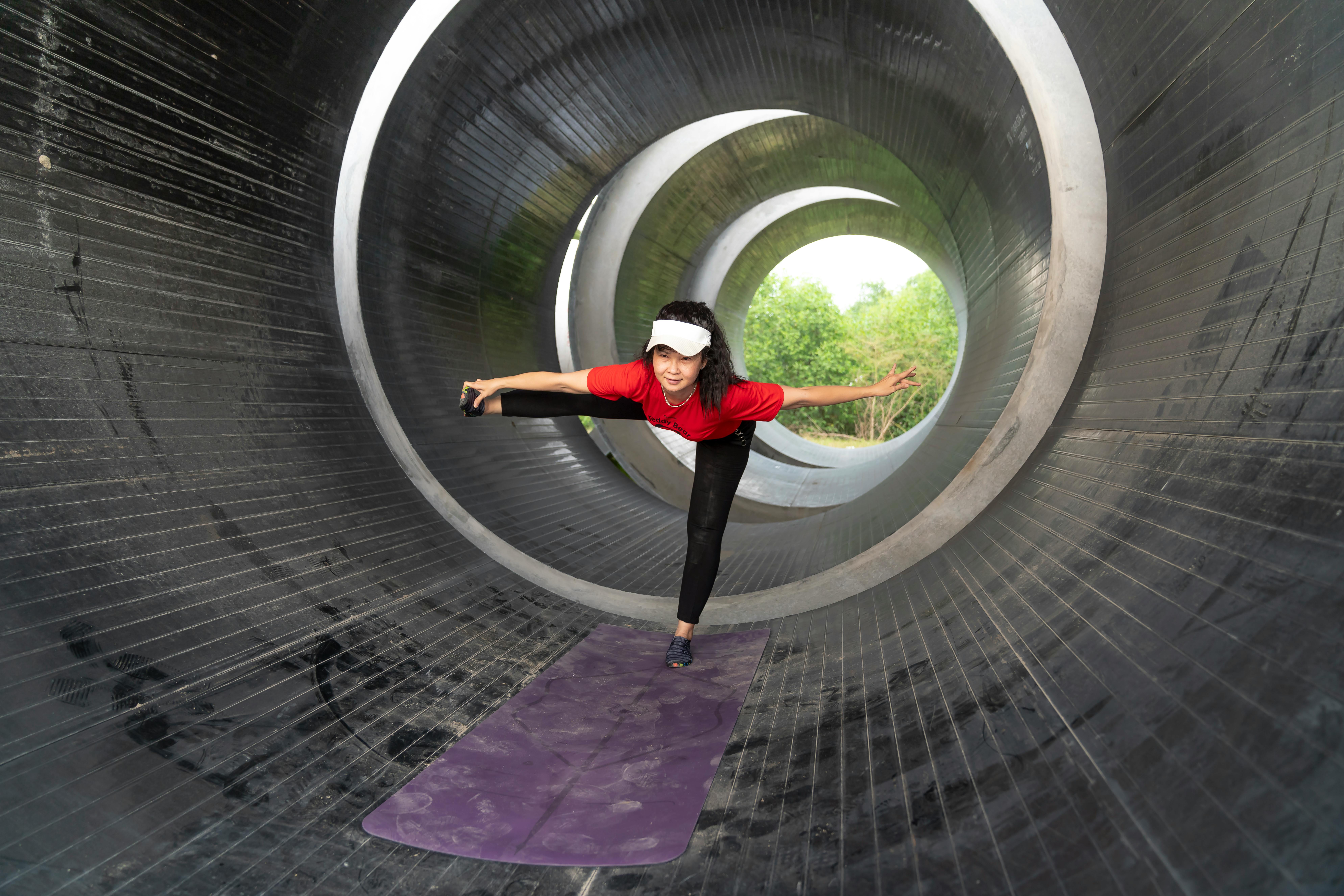 Girl Exercising in Tunnel · Free Stock Photo