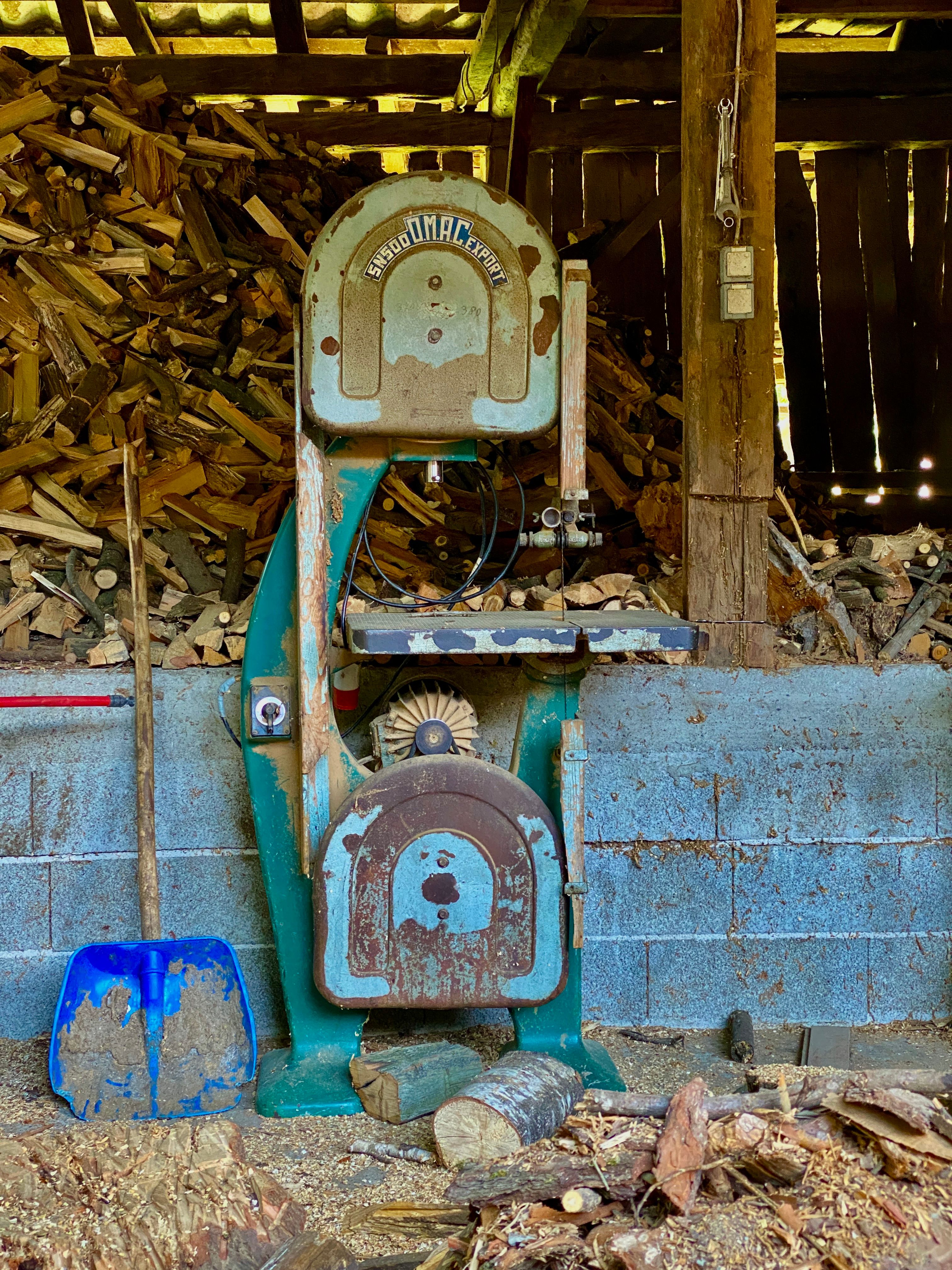 Old Machine near Pile of Woods · Free Stock Photo