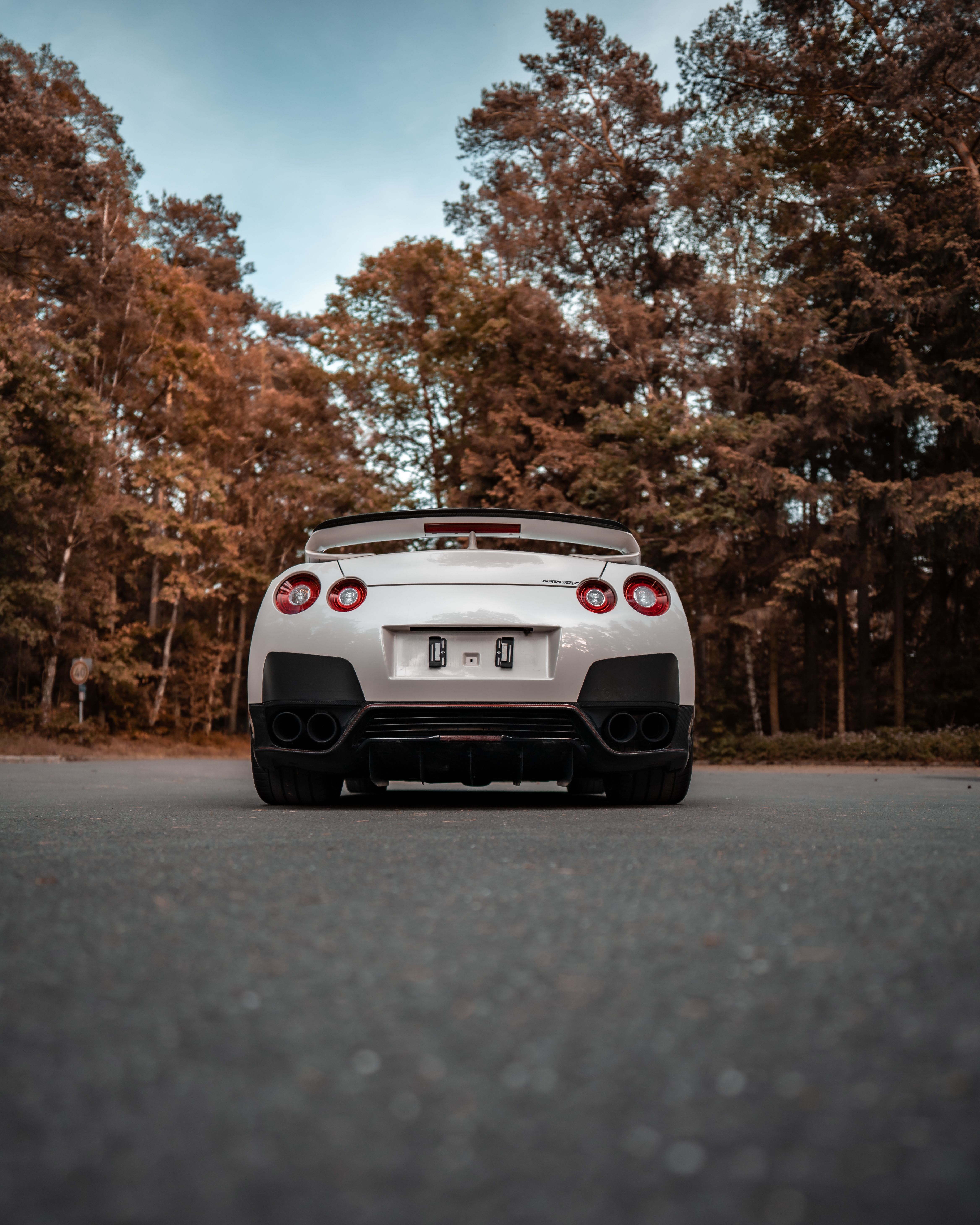 White Car Parked on Road In Between Trees · Free Stock Photo