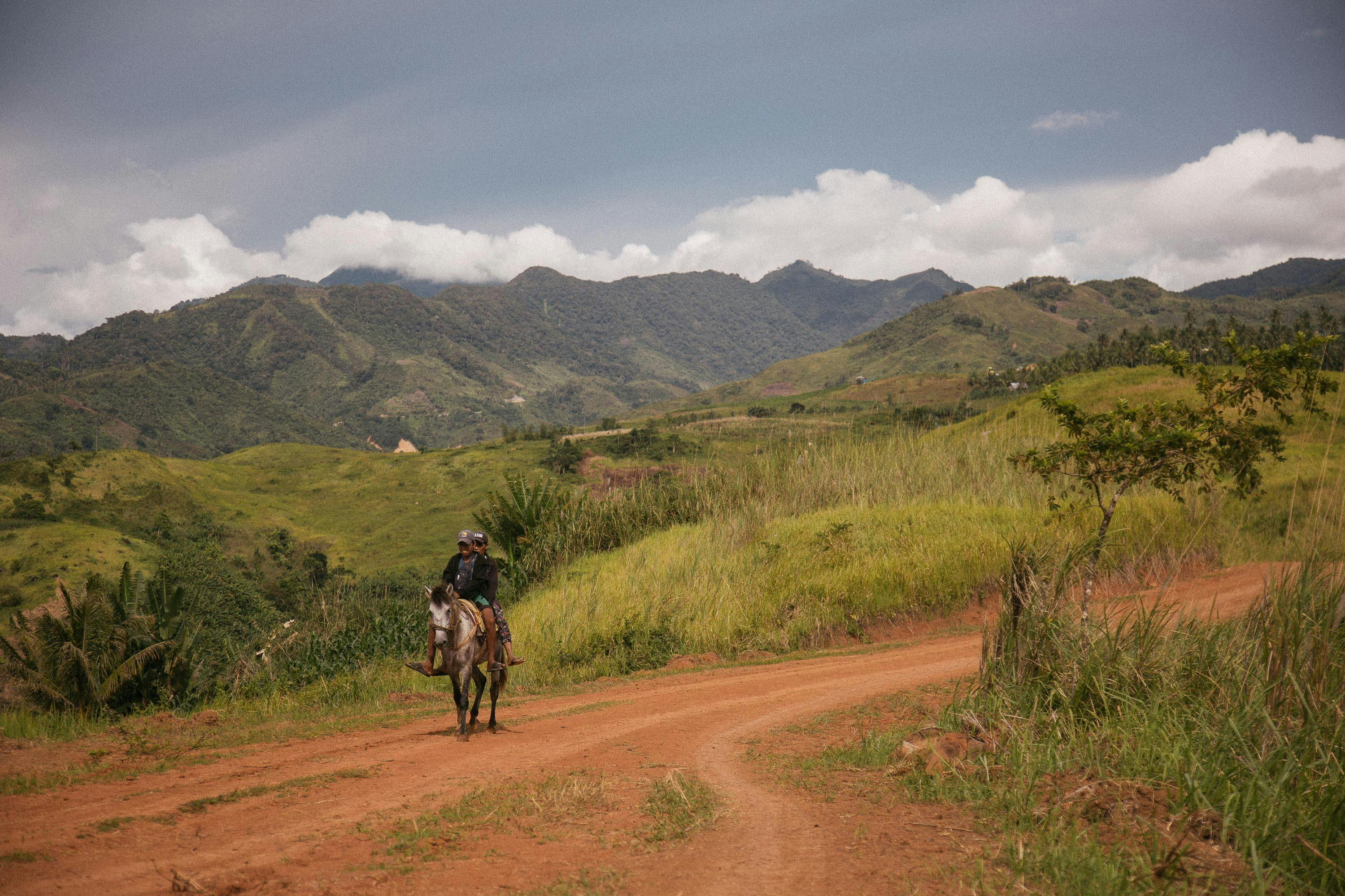 Men Riding a Horse on a Dirt Road · Free Stock Photo