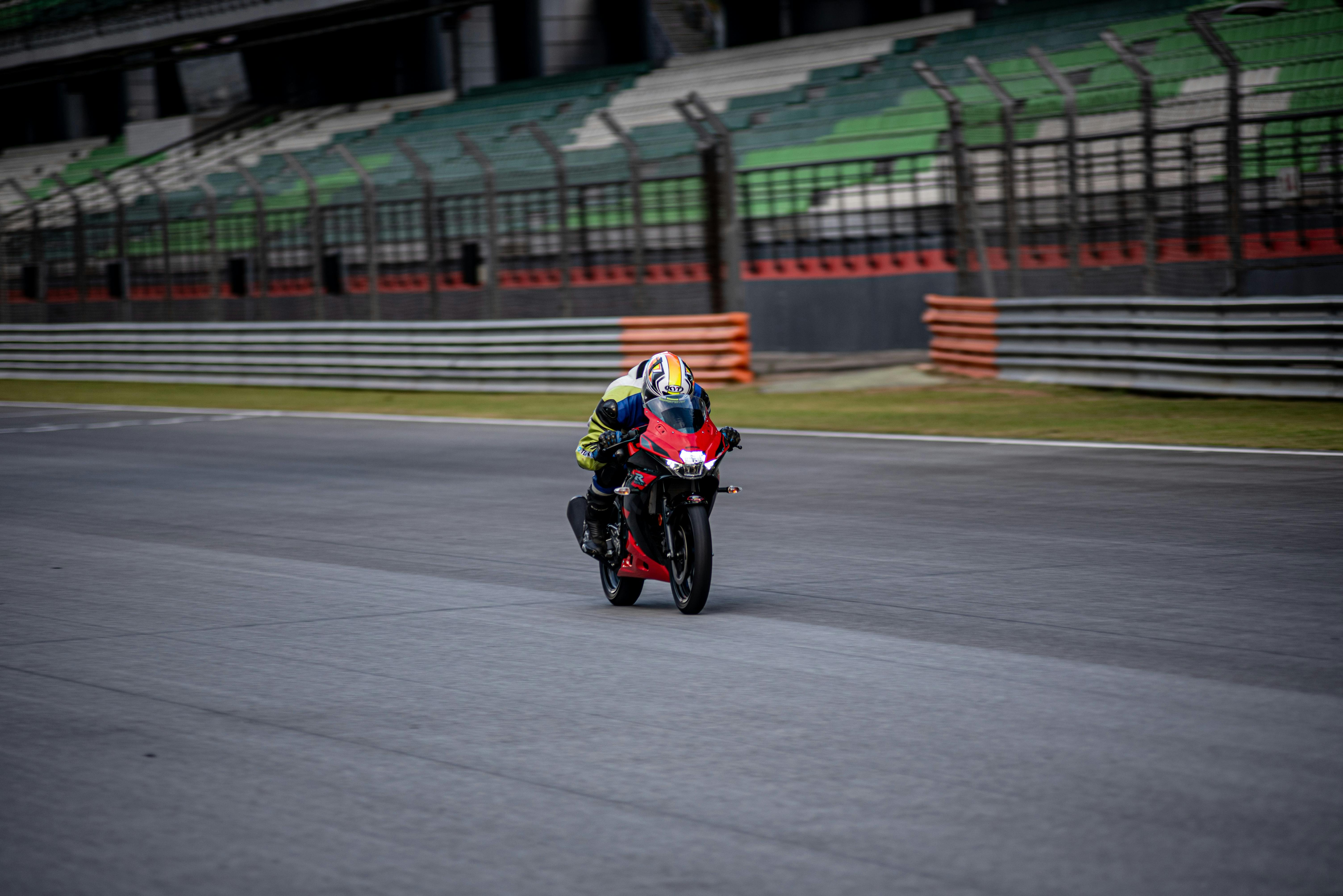 A Racer Riding His Motorcycle in the Race Track · Free Stock Photo