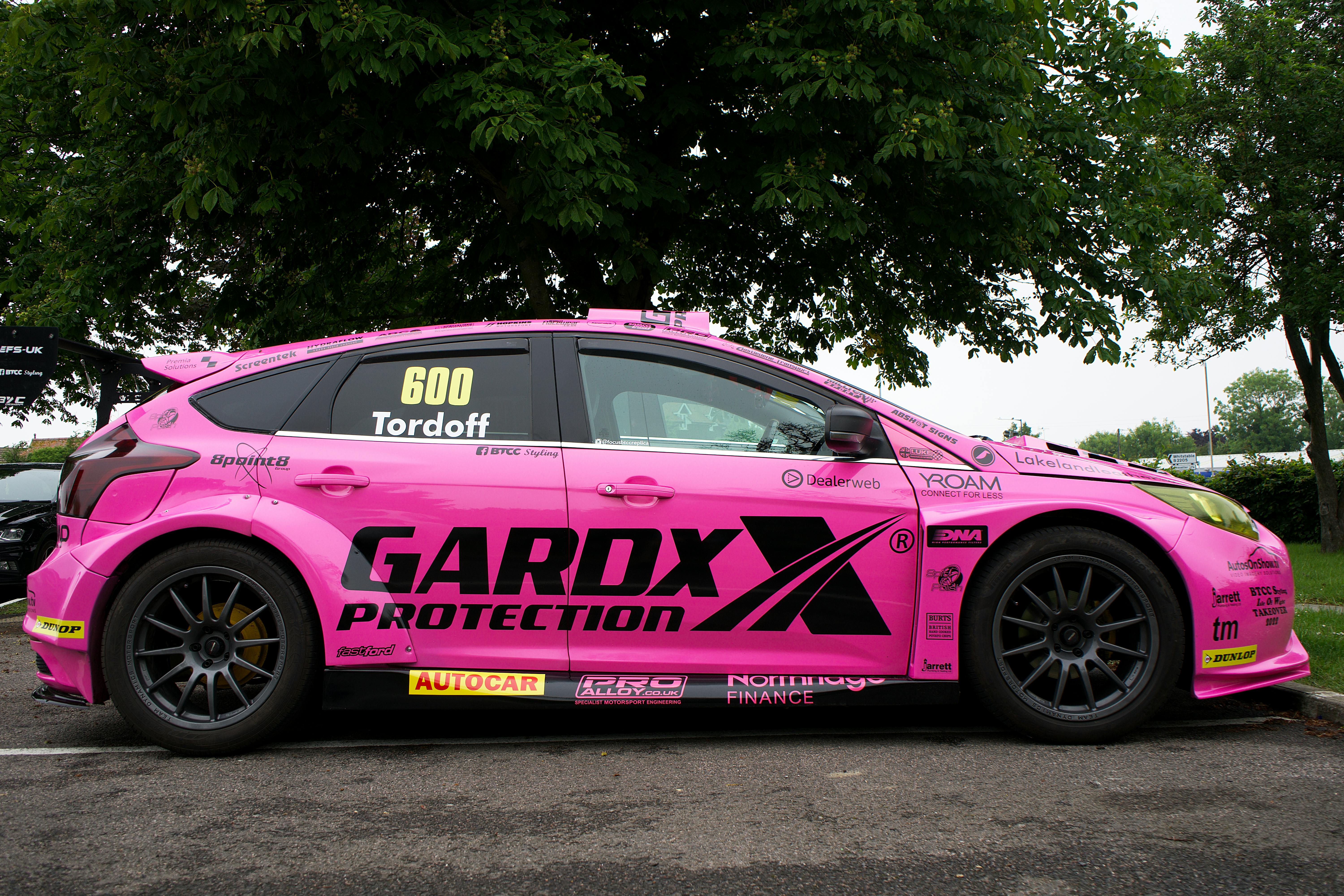 A Pink Sports Car Parked on the Road · Free Stock Photo