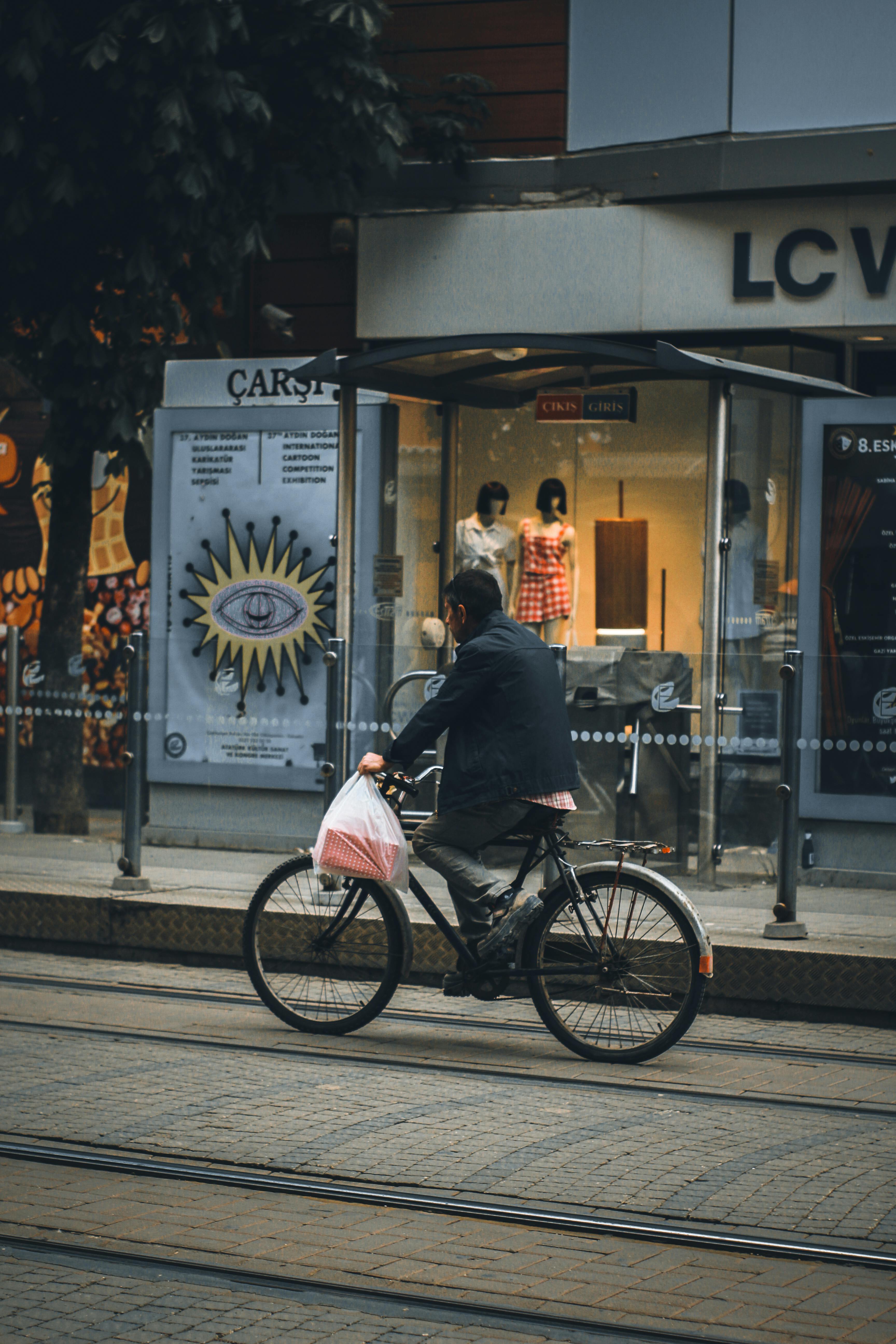 Man Riding a Bicycle on the Street · Free Stock Photo