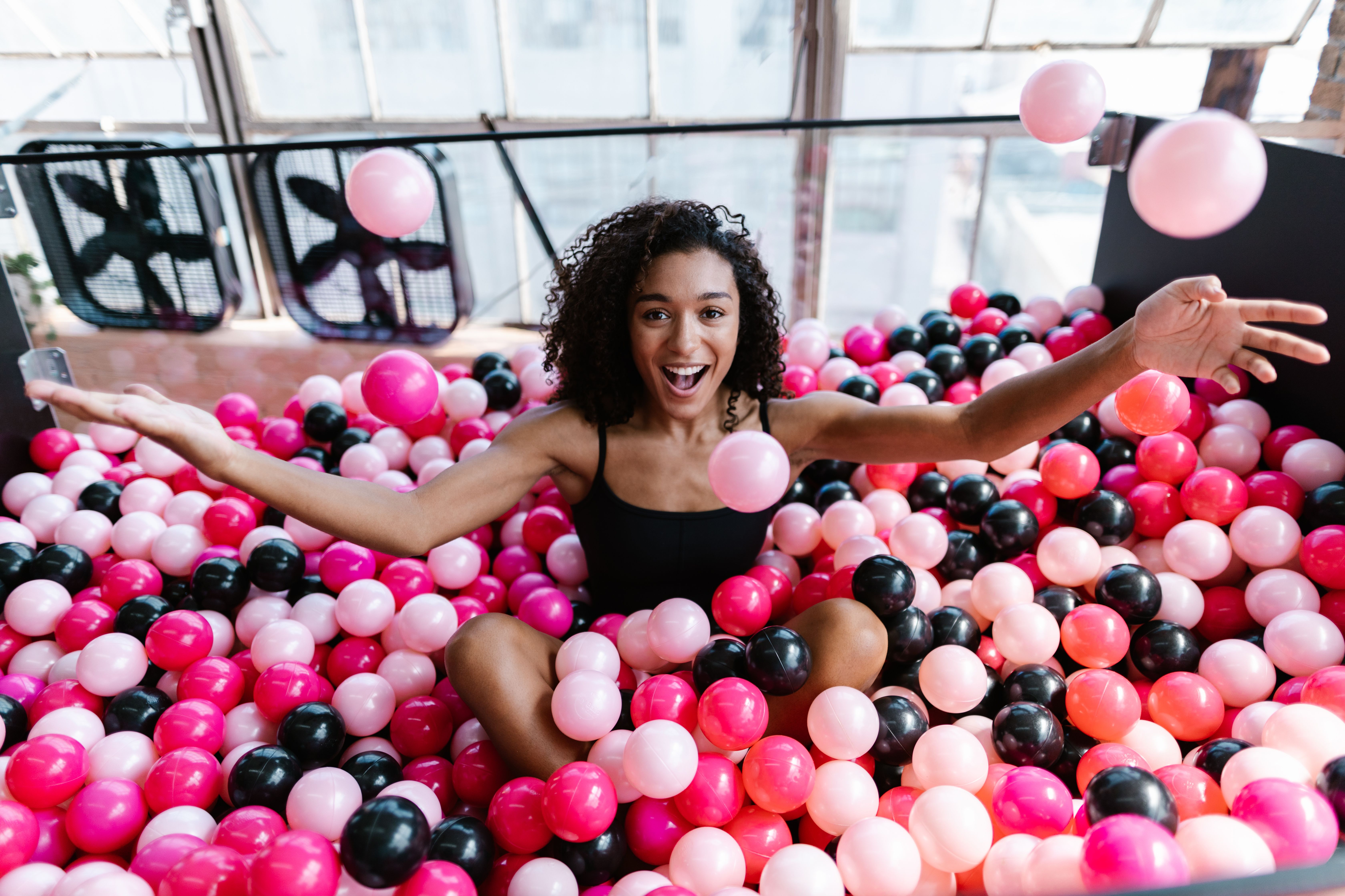 Man Sitting in a Ball Pit Pool · Free Stock Photo
