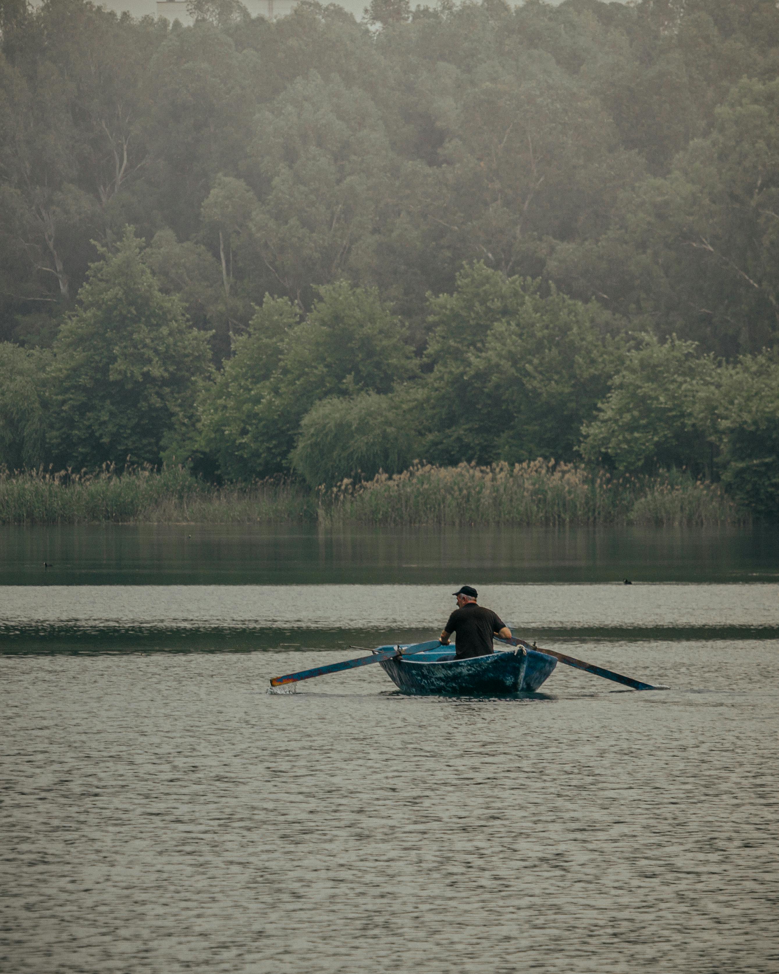 Man Riding a Rowing Boat on a Lake · Free Stock Photo