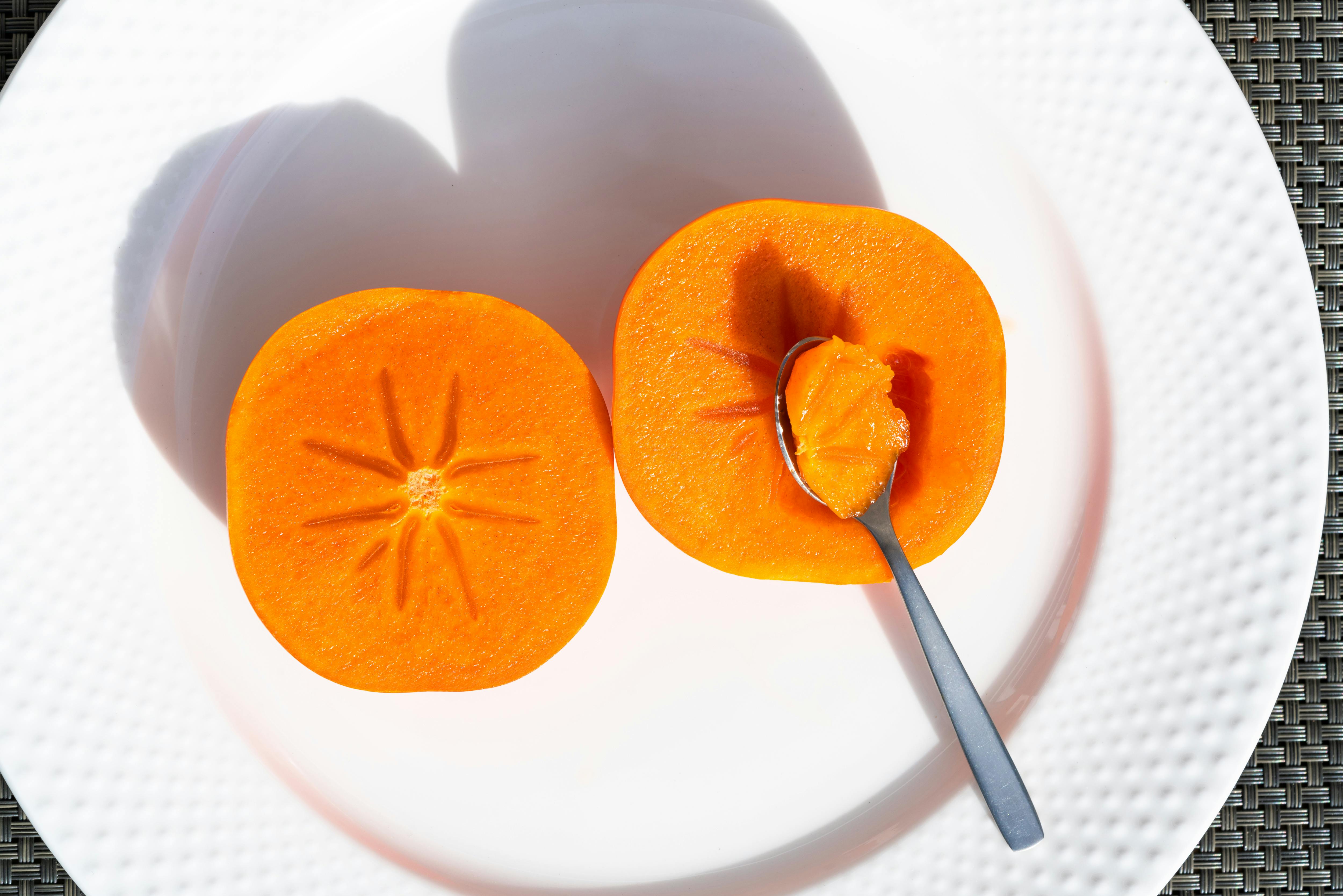 Sliced Persimmon on a Plate · Free Stock Photo
