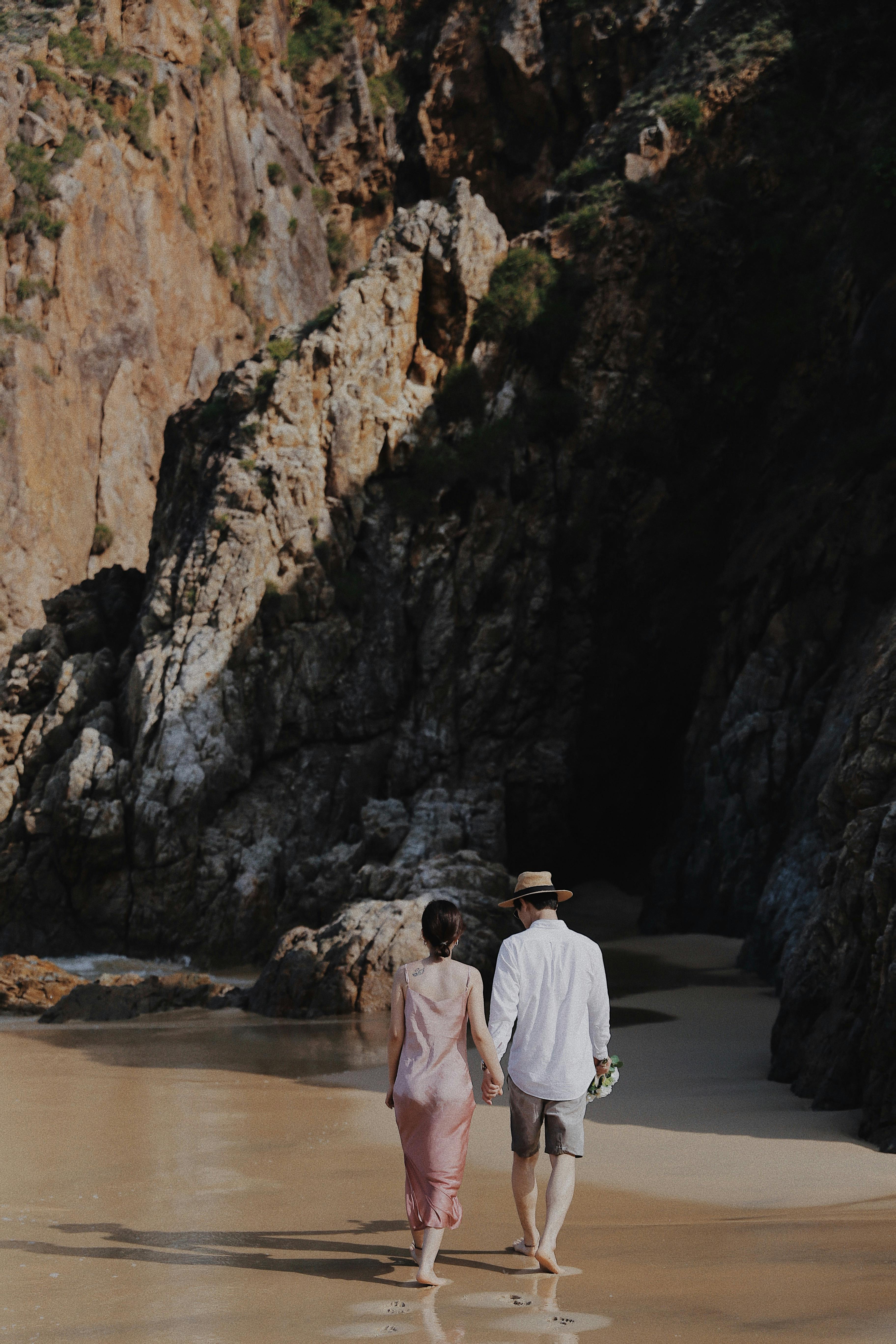 Man Walking Through Passage Between Rocks · Free Stock Photo