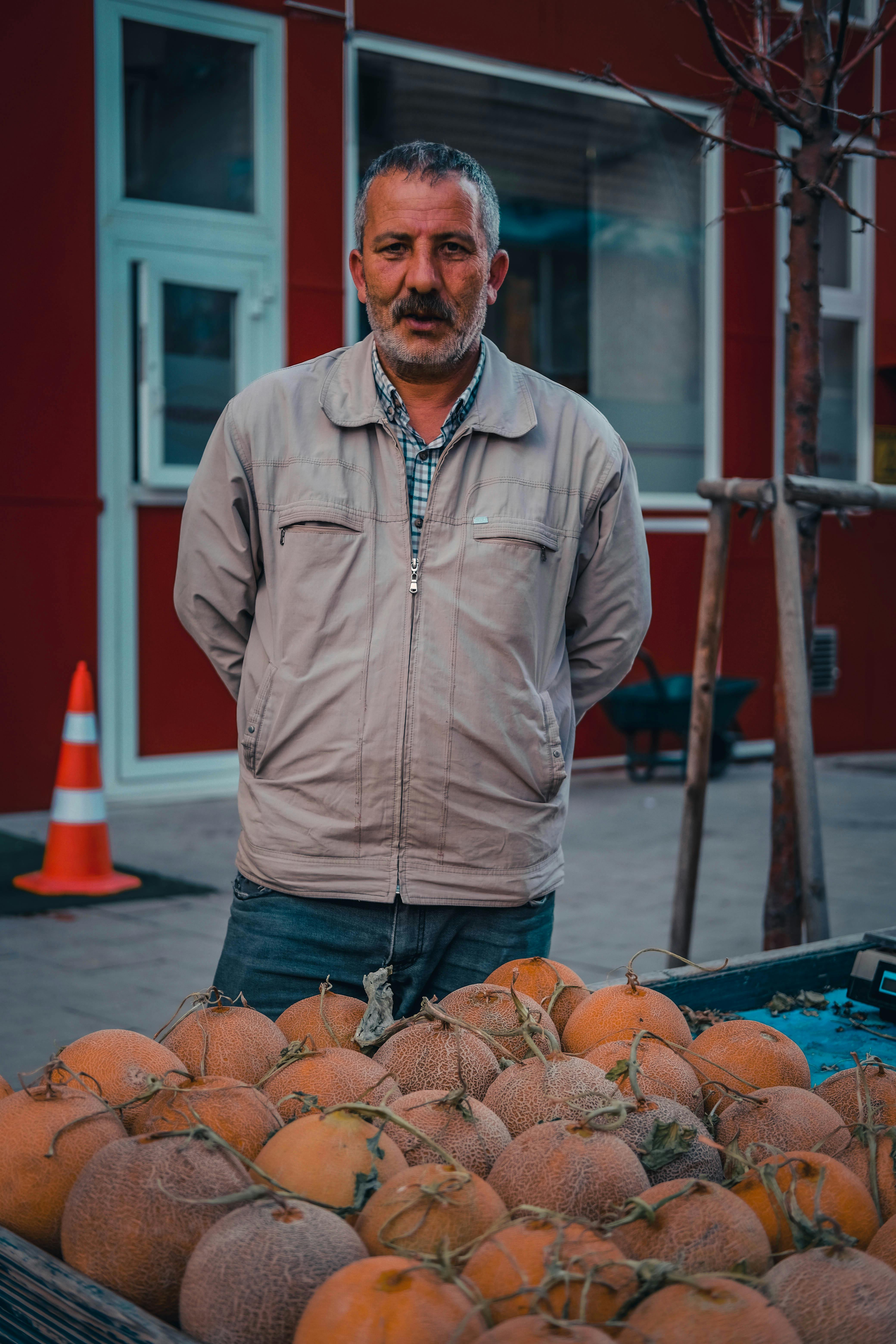 Photo of a Seller Selling Pumpkins · Free Stock Photo