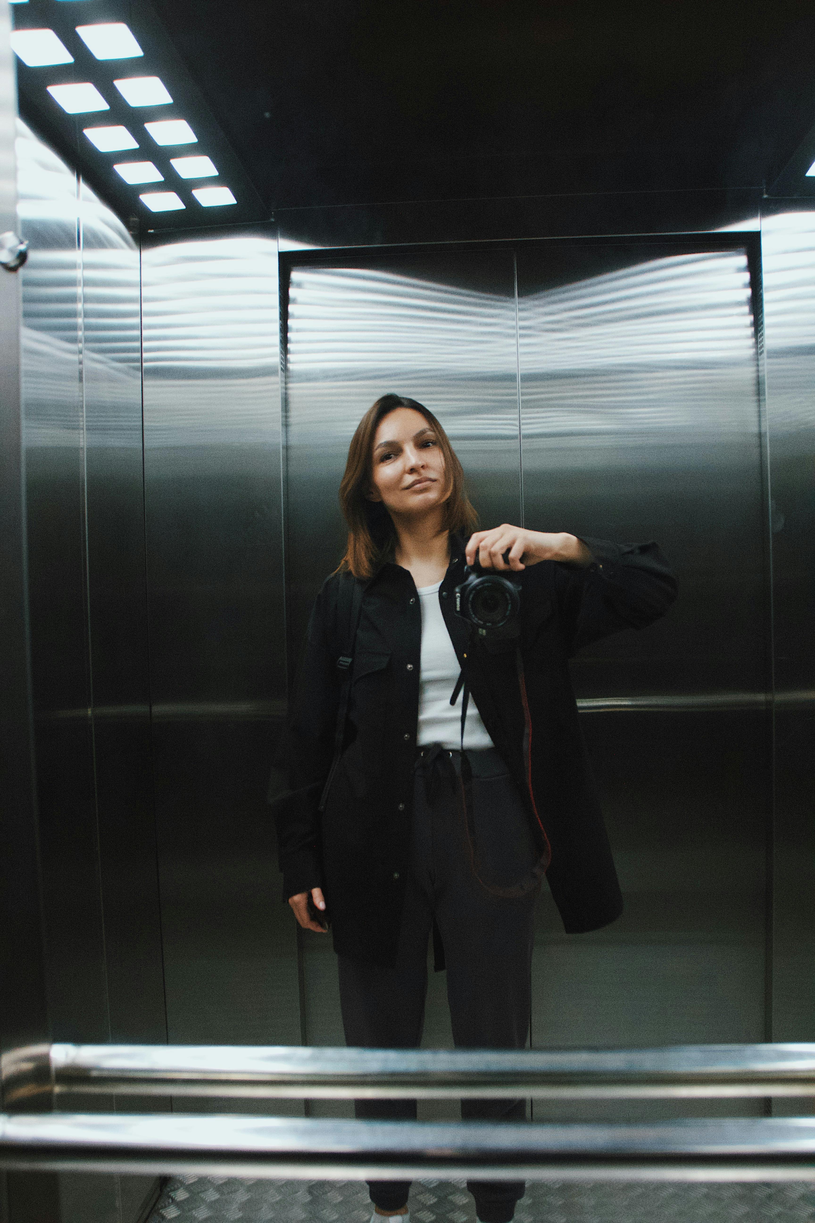 Mirror Reflection of Woman in Elevator · Free Stock Photo