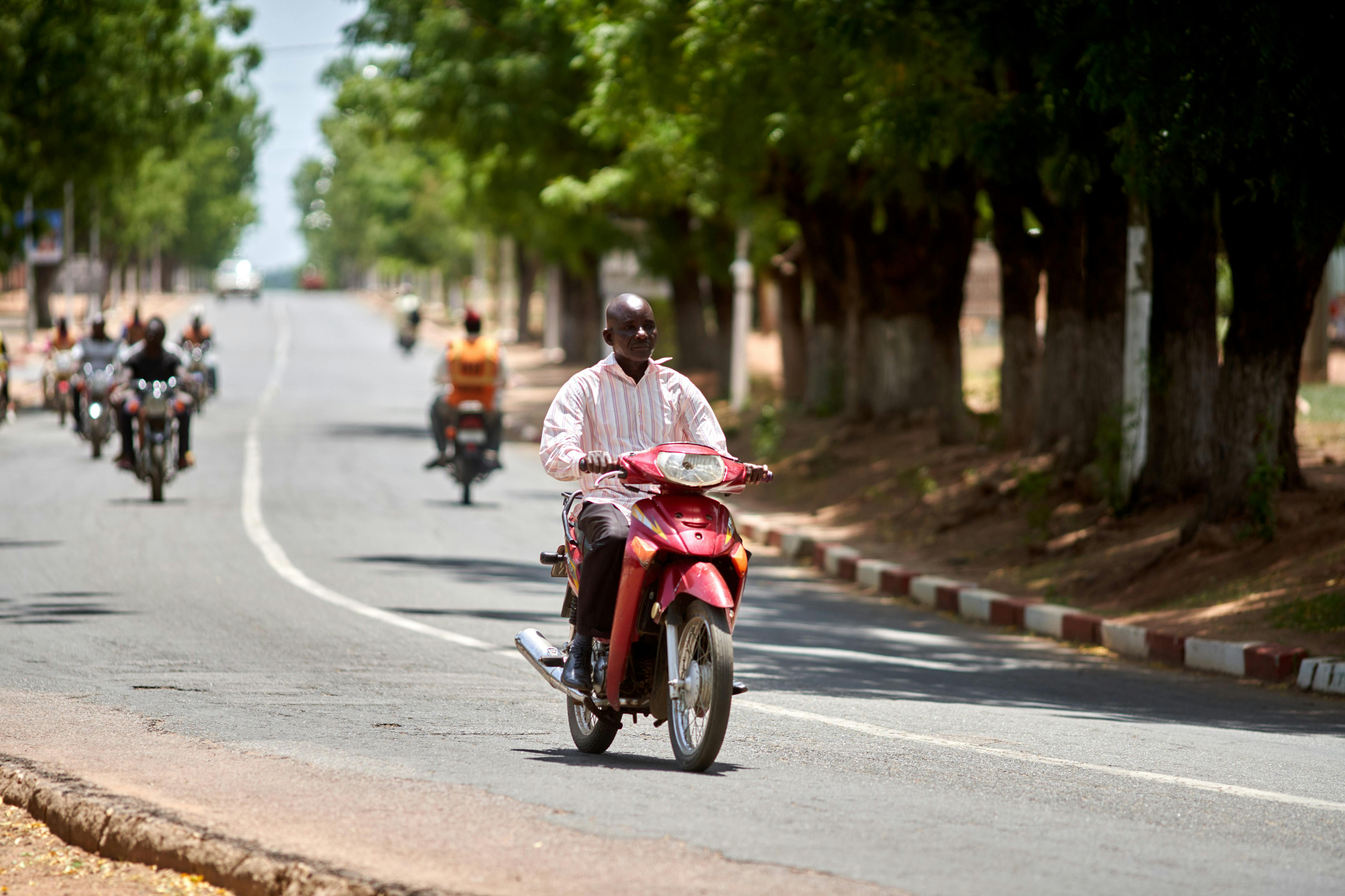 A Man Driving a Red Motorcyle · Free Stock Photo