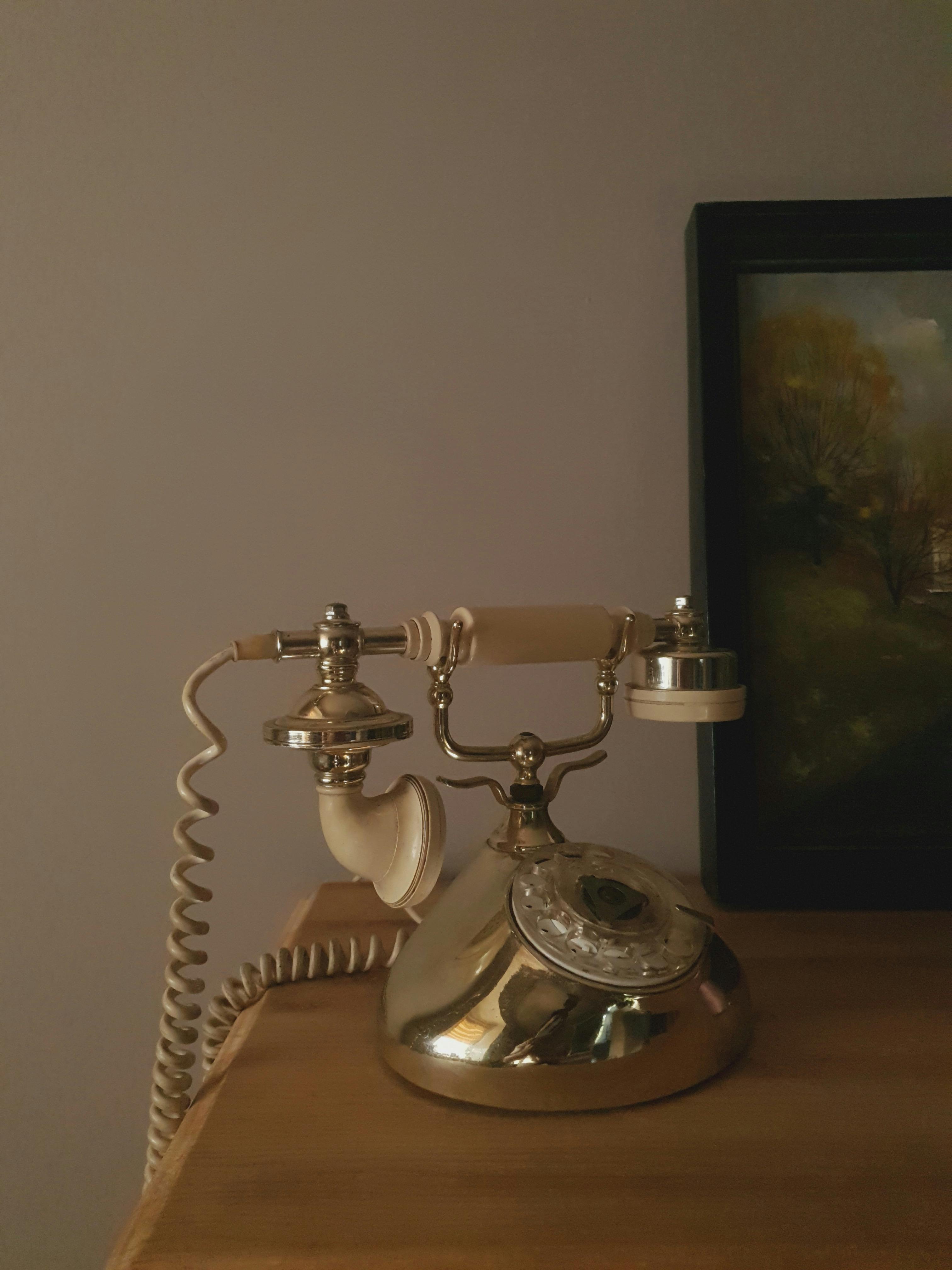 Silver Rotary Phone on Wooden Table · Free Stock Photo