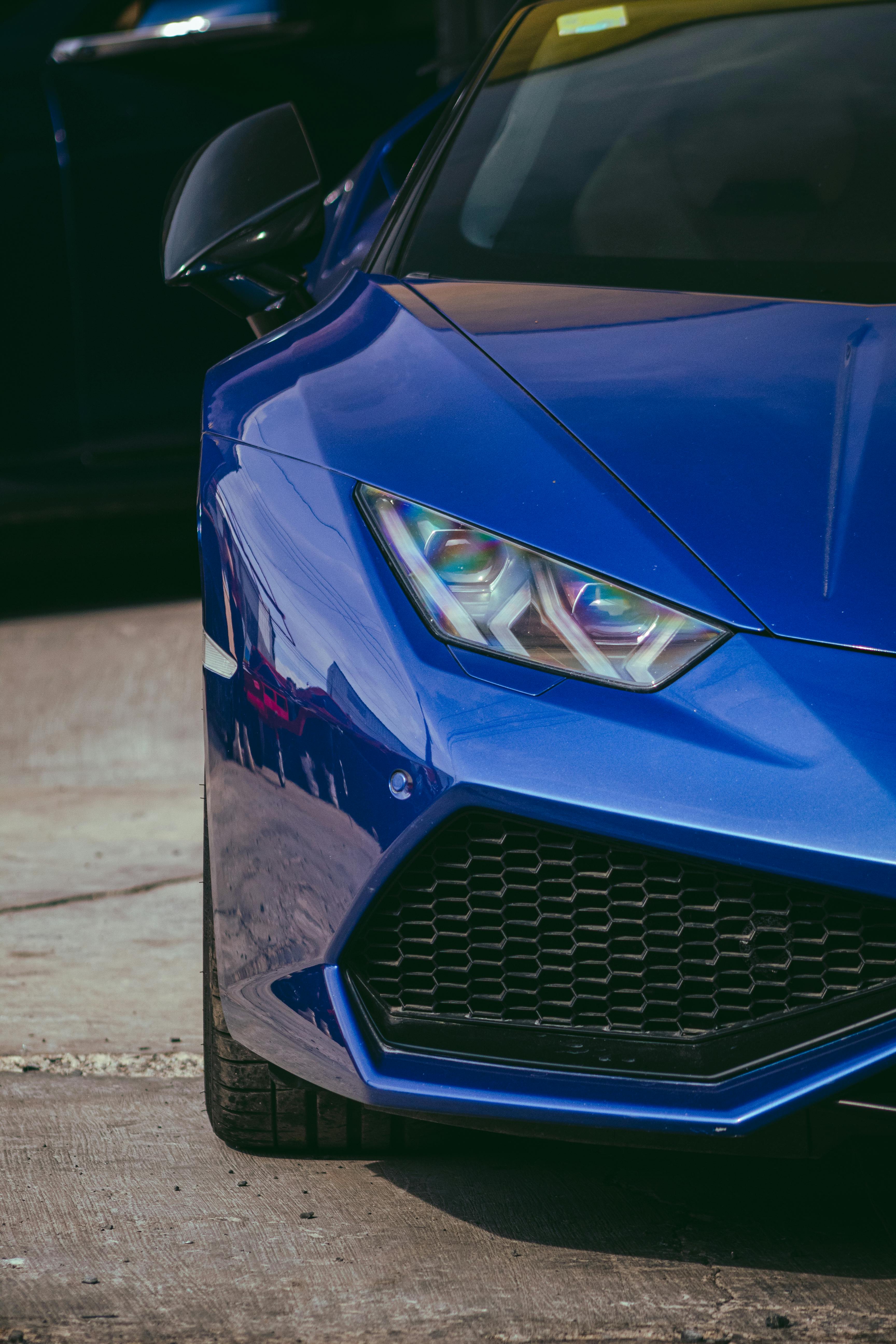 Blue and Red Car in a Dark Room · Free Stock Photo