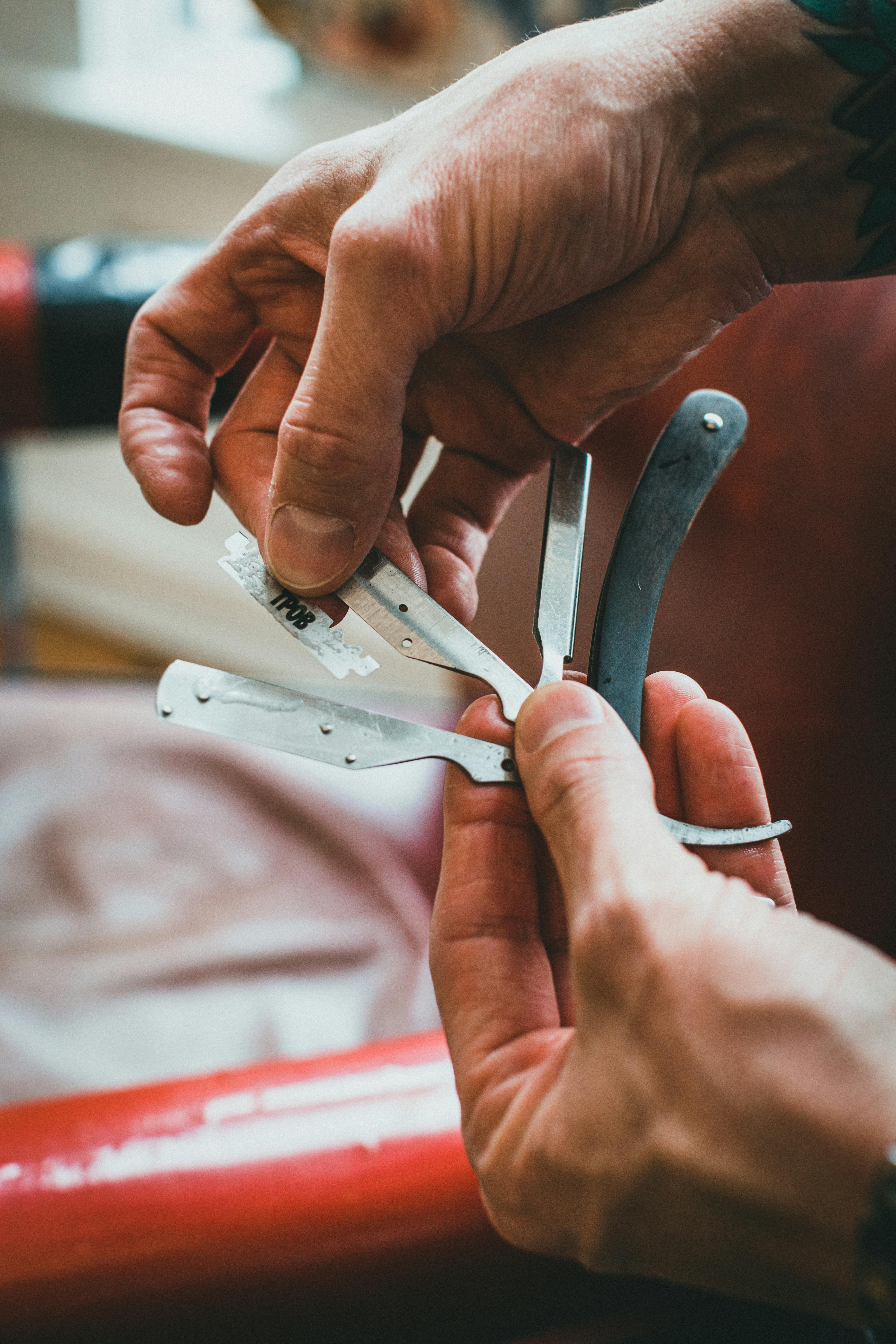 A Person Holding a Set of Razors · Free Stock Photo