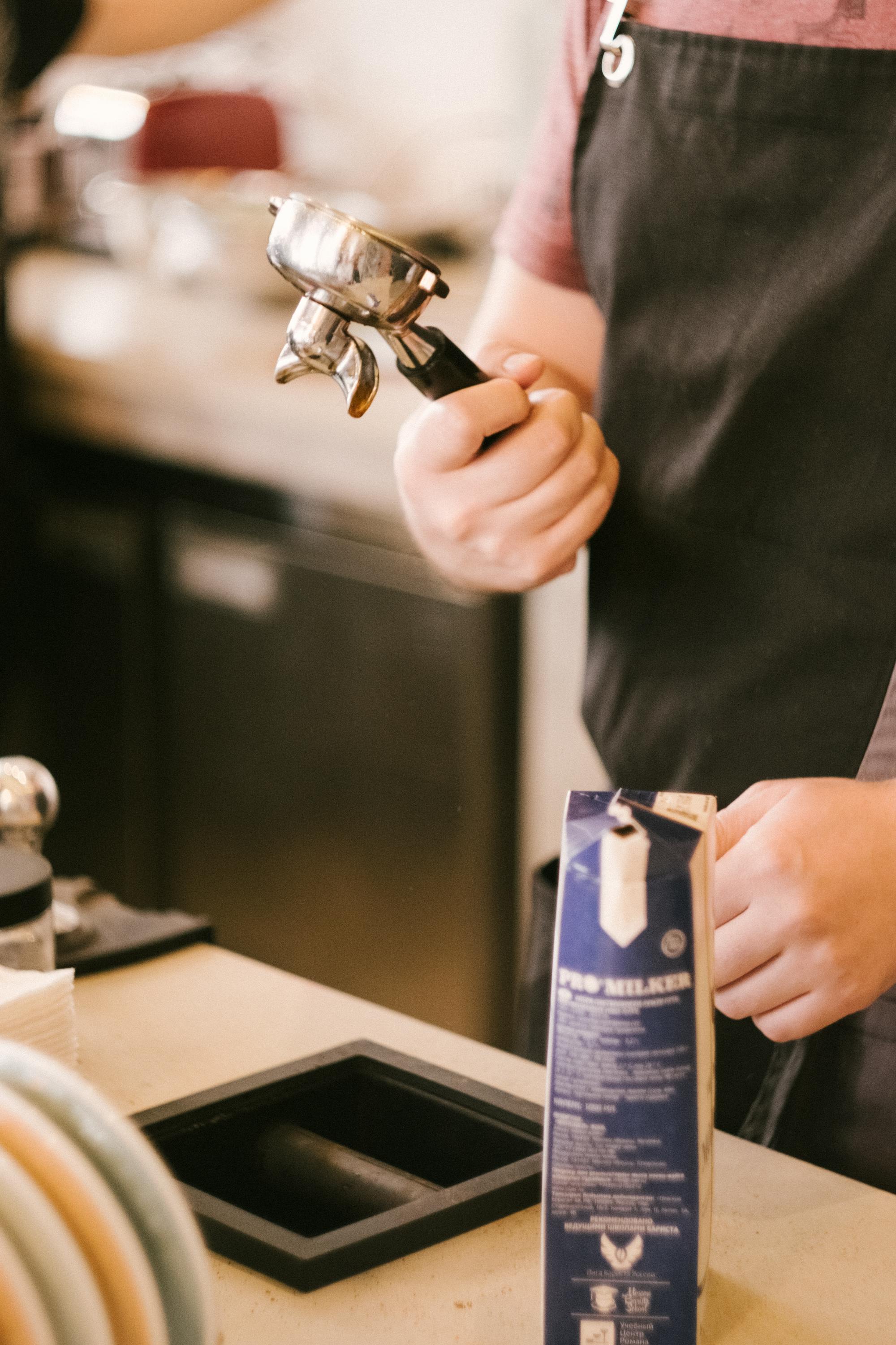 A Man in Black Shirt Making Coffee while Holding a Portafilter · Free ...