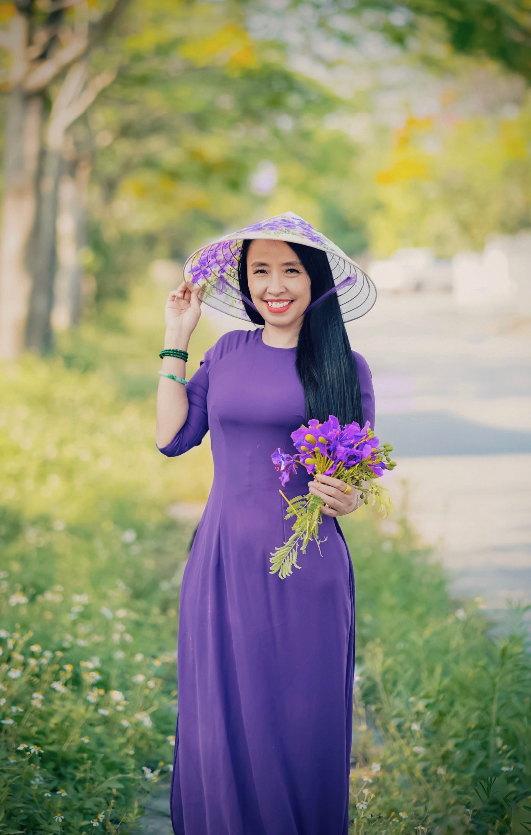 Woman in Purple Dress Holding Purple Flowers · Free Stock Photo