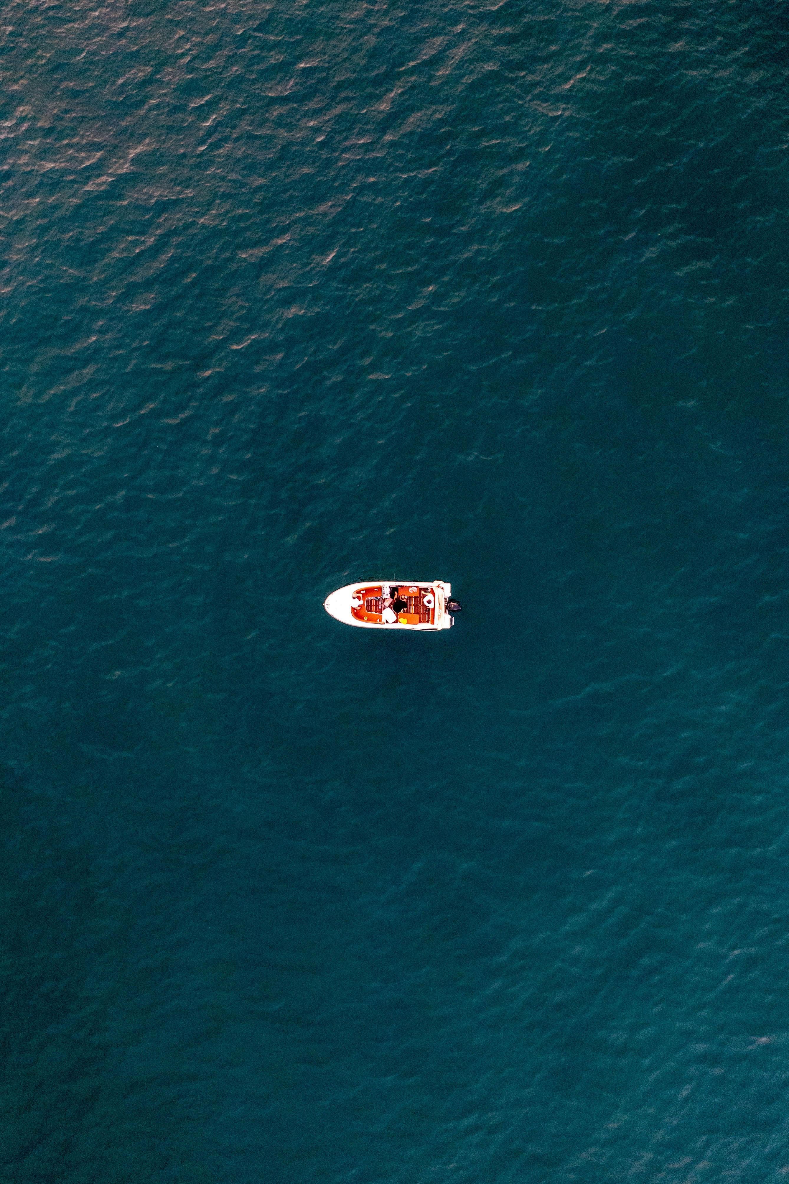 Top View Photo of Boat on Ocean · Free Stock Photo
